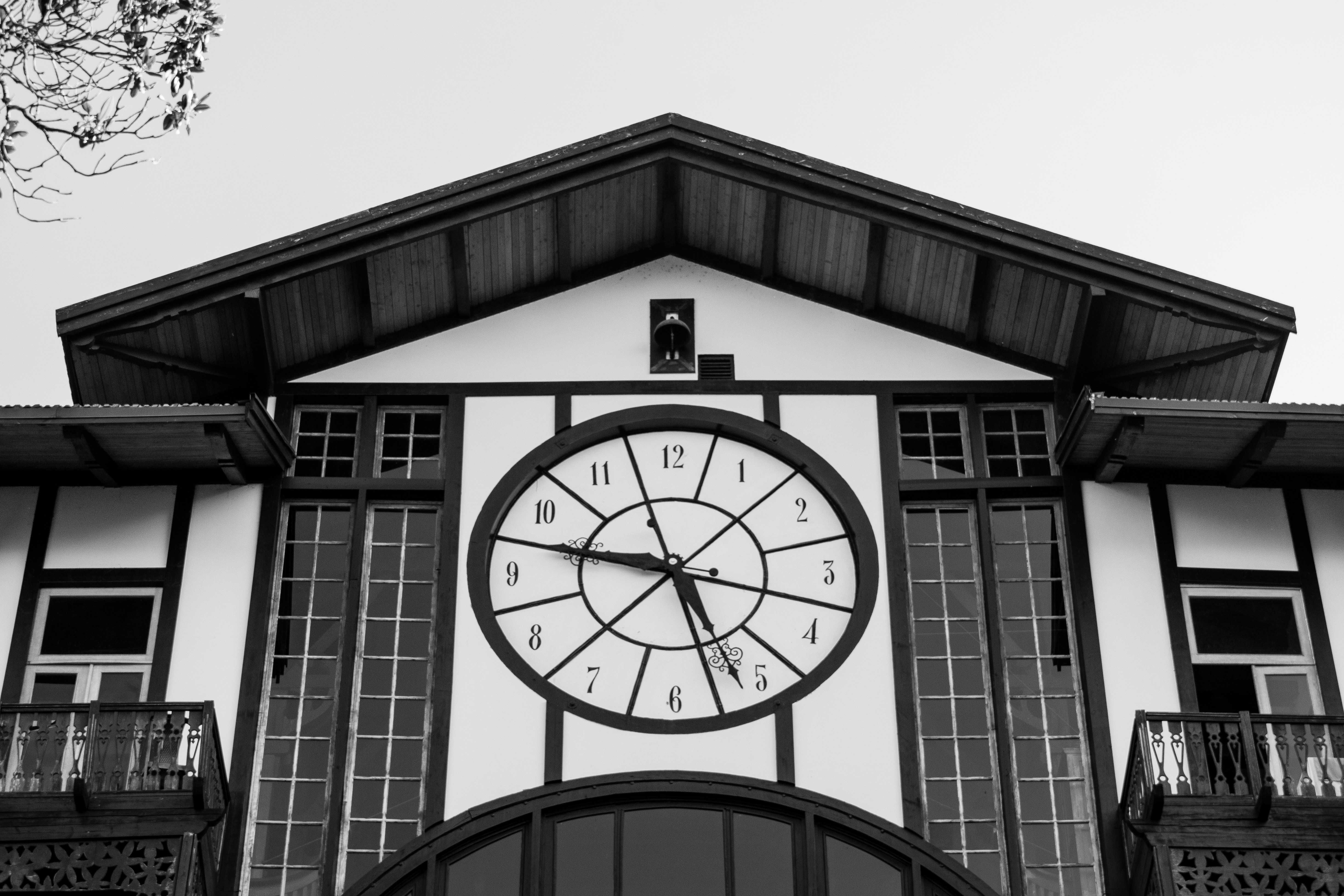 A striking black and white depiction of a clock tower, showcasing its intricate architectural details and large clock face.