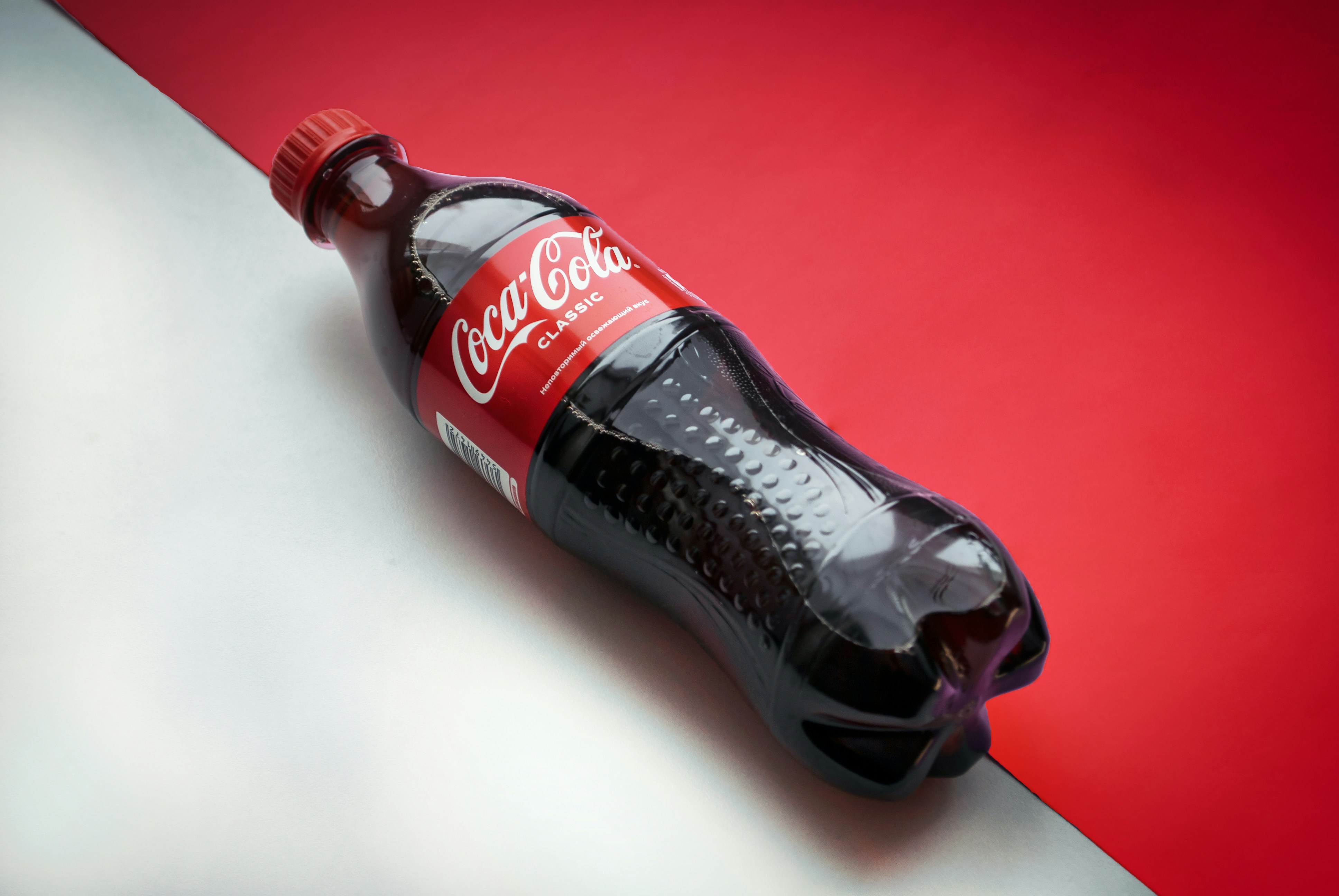 A coca cola bottle sitting on top of a table photo – Free Beverage ...