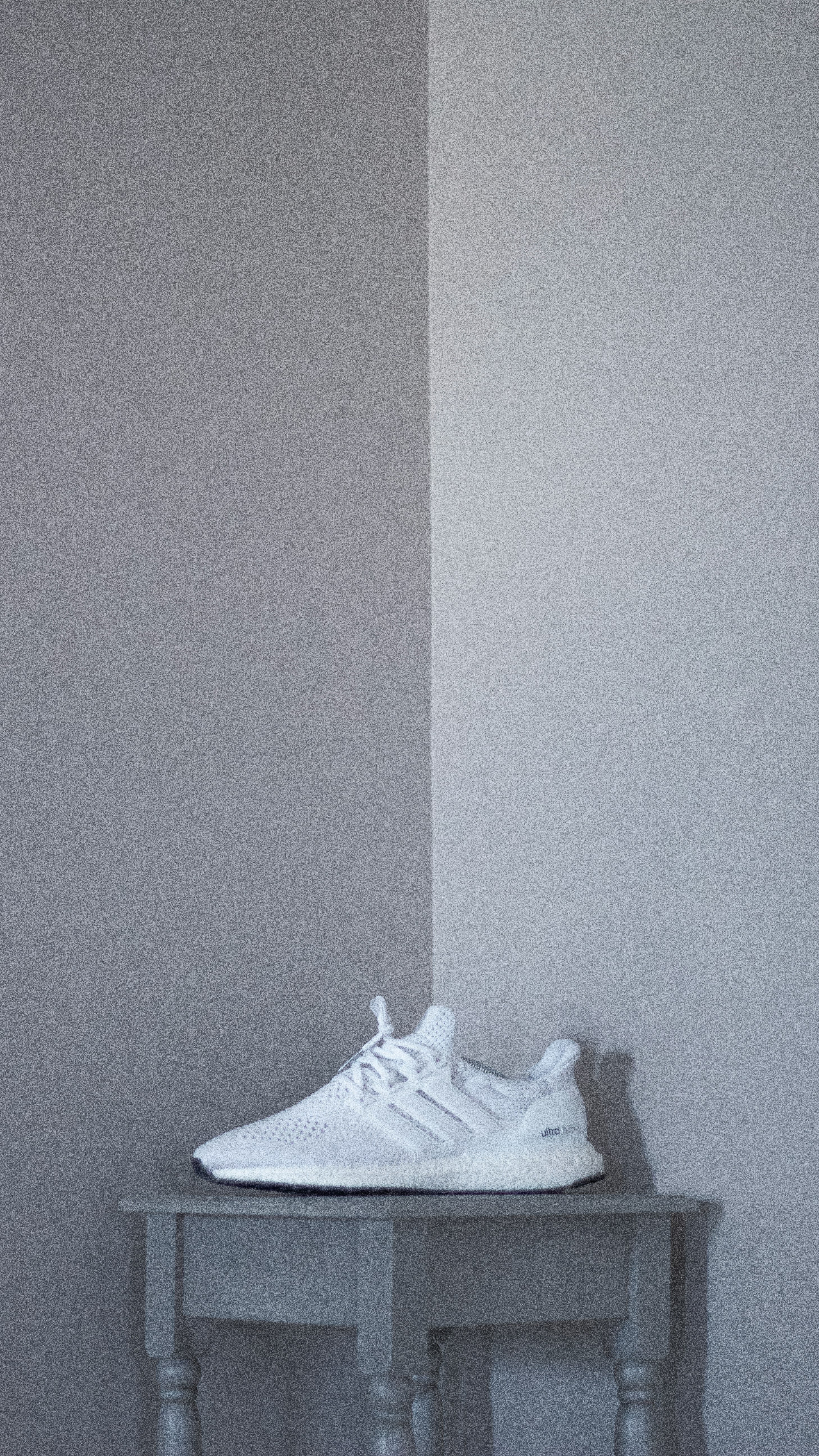 A white adidas sneaker sitting on top of a table photo – Free Clothing ...