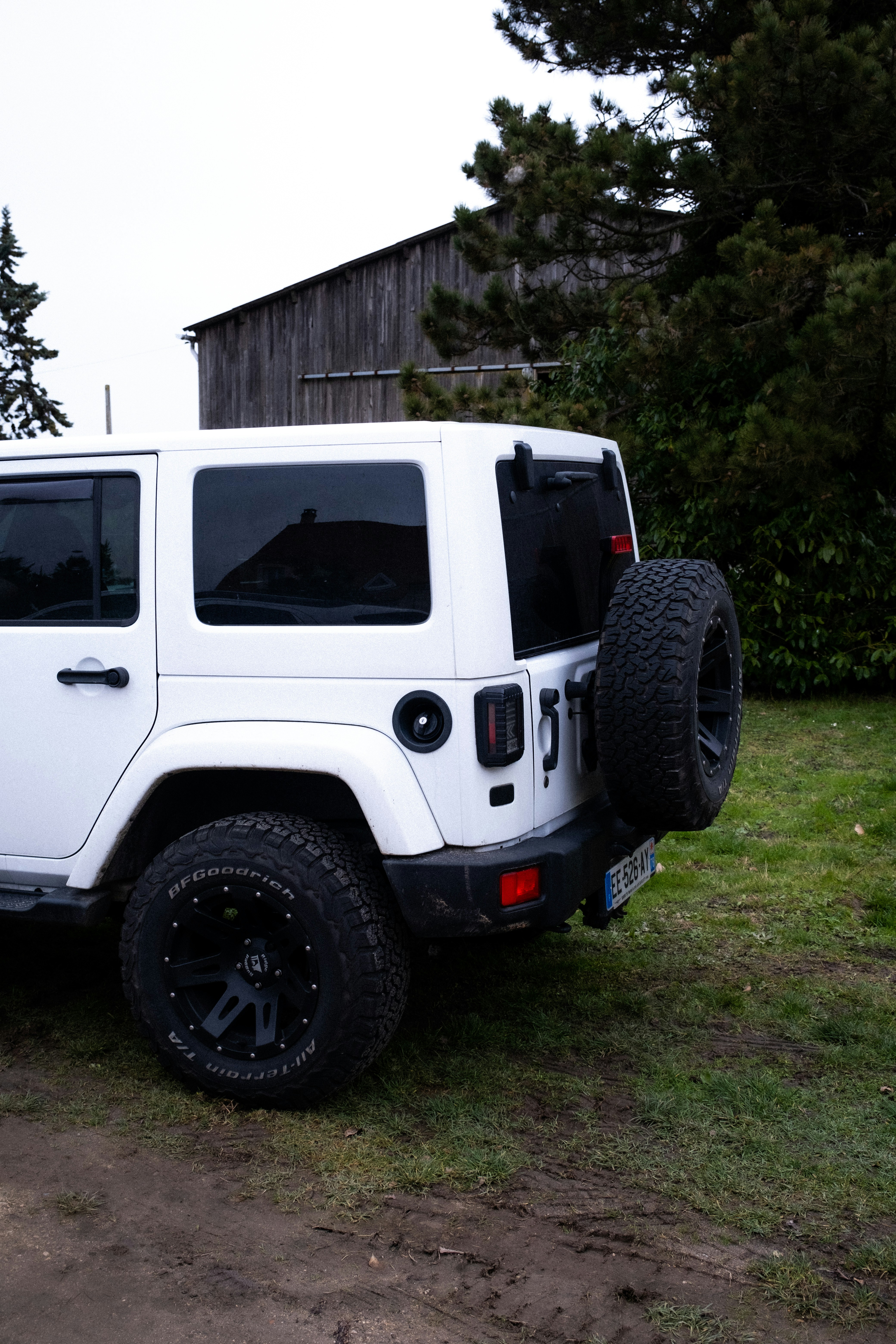 A white jeep parked in front of a barn photo – Free France Image on ...