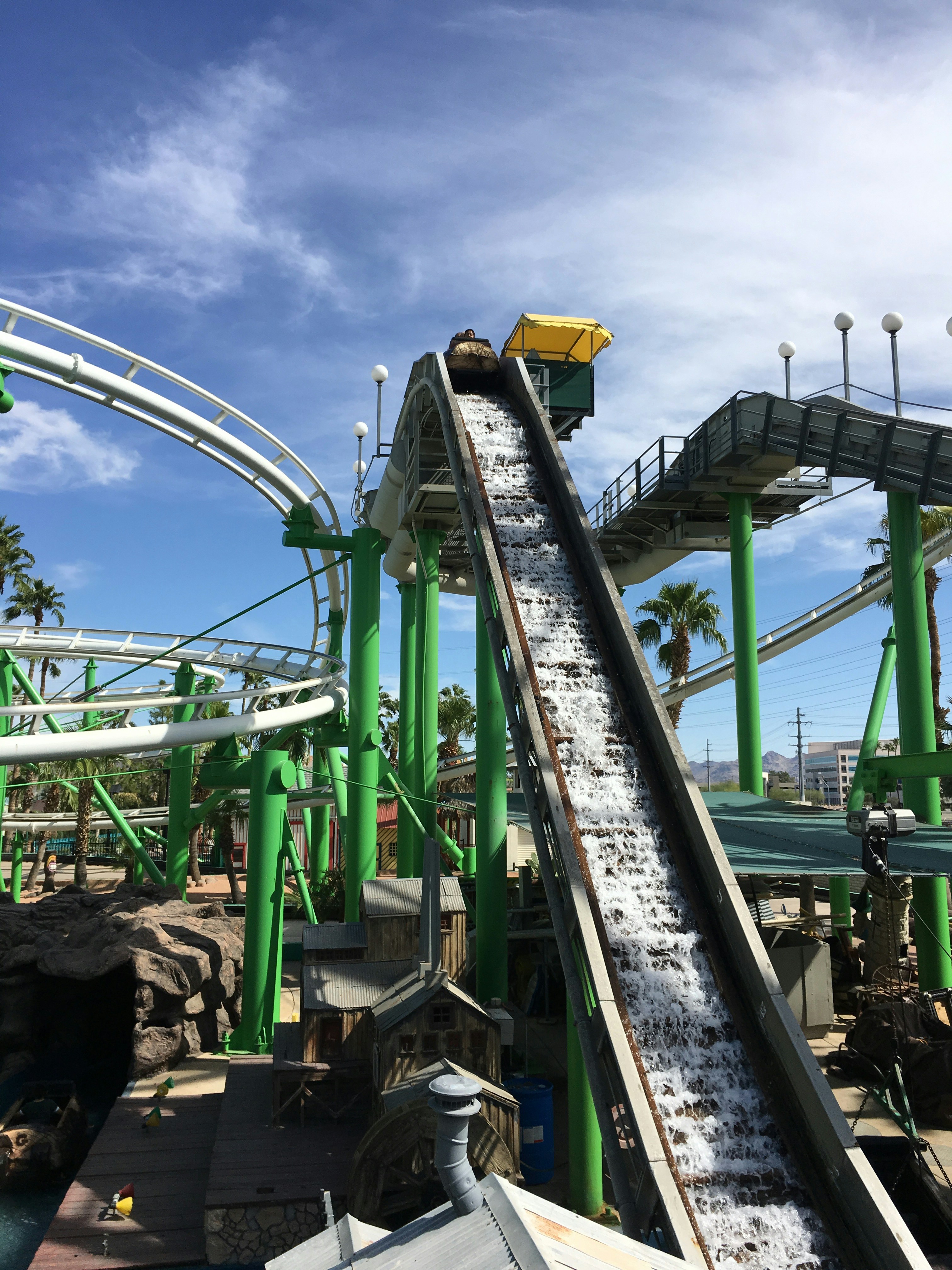 a water slide going down the side of a roller coaster
