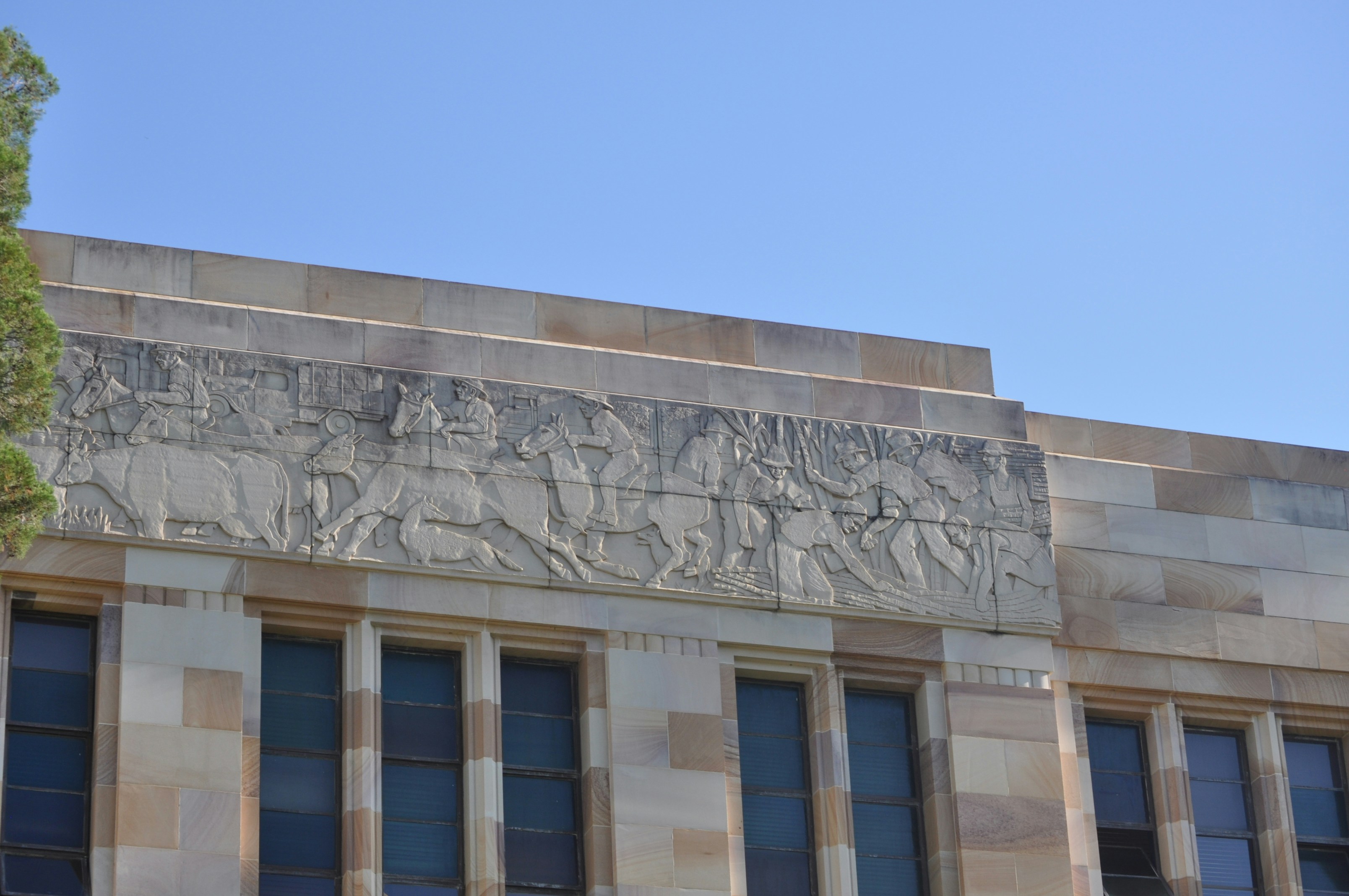 A building with a large stone carving on the side of it photo – Free ...