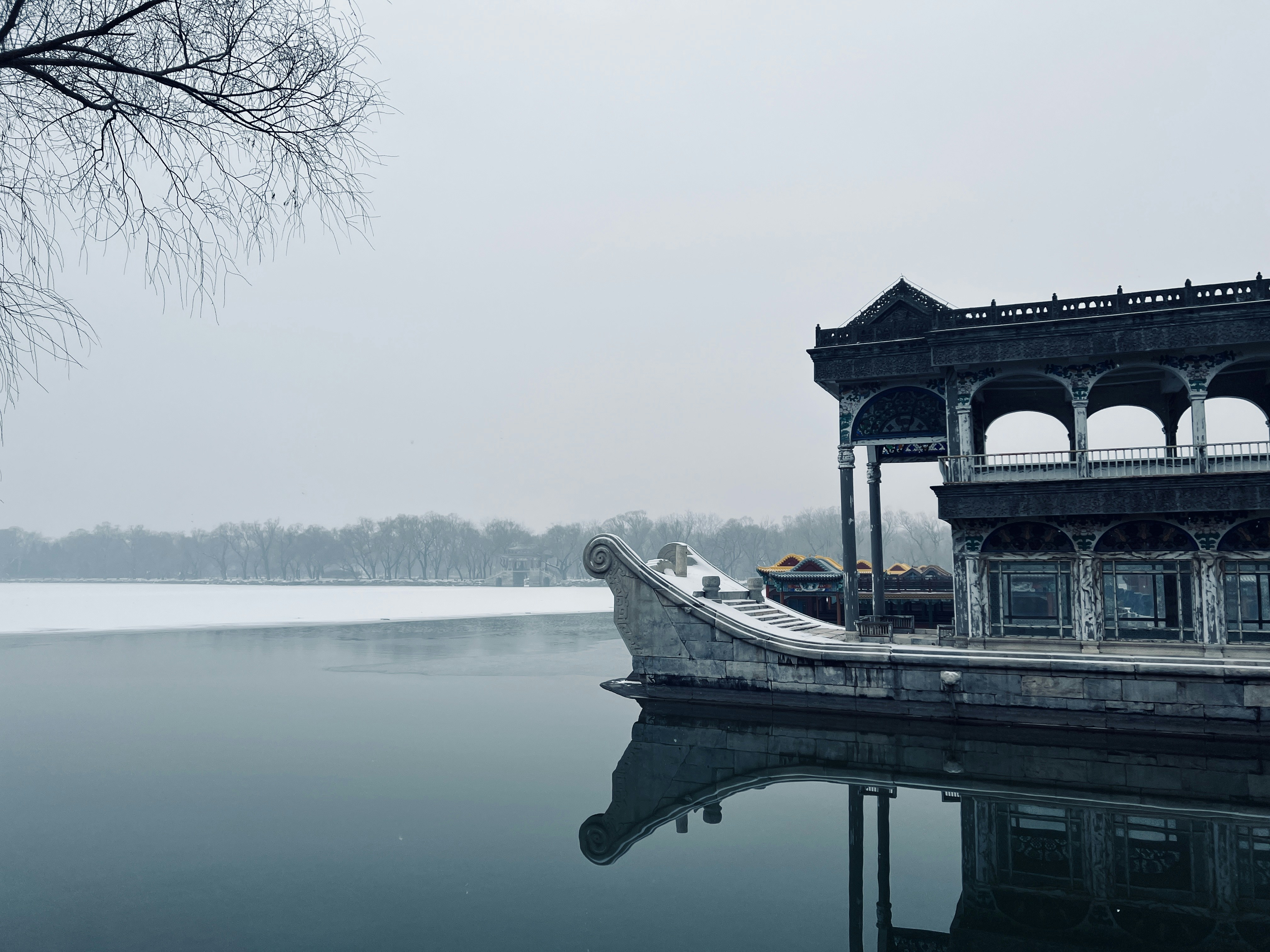 Carved Echoes: A Lakeside Pavilion Extends Over a Silent Winter Lake