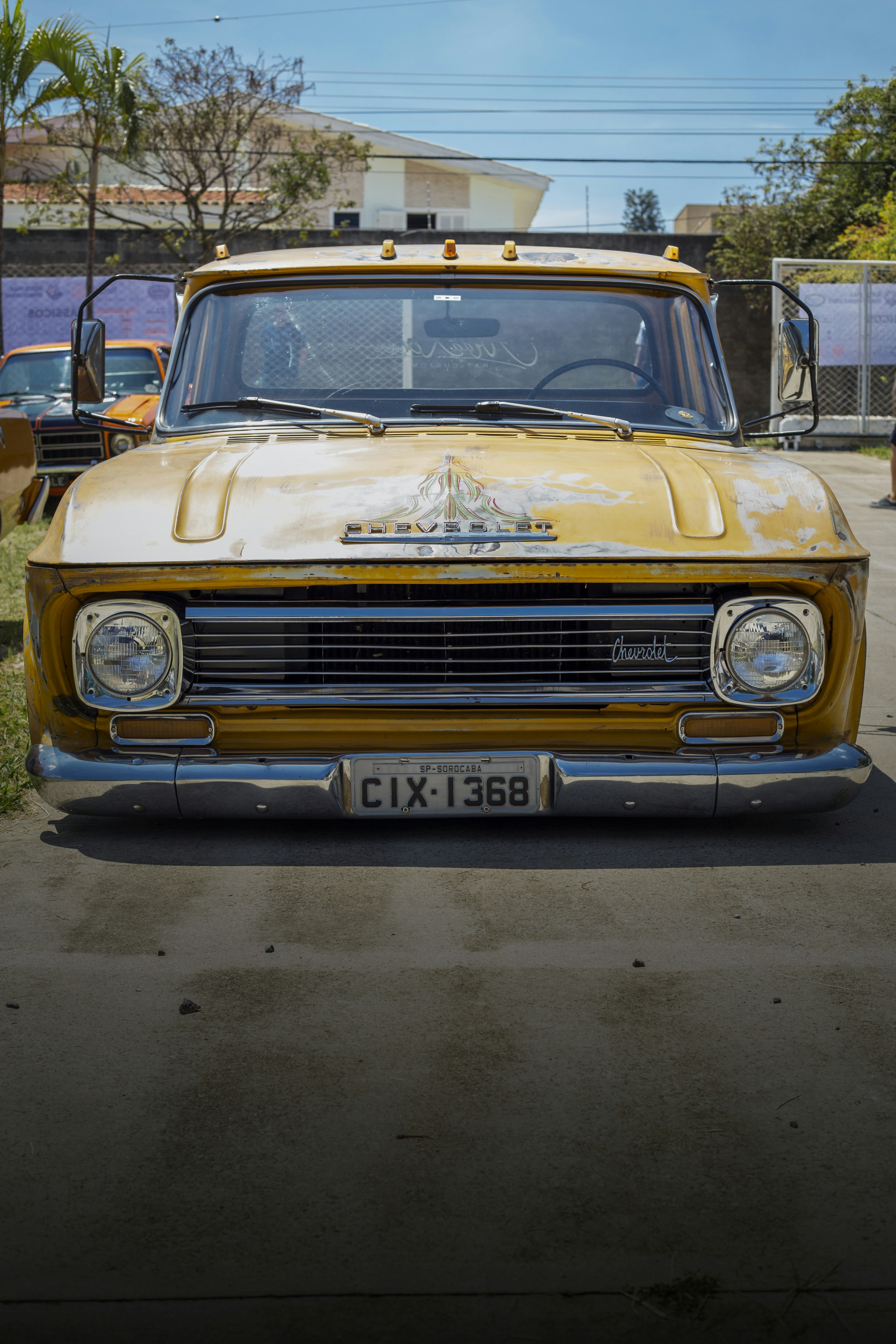 Rust and Chrome in the Sun: Front View of a Vintage Chevrolet Pickup