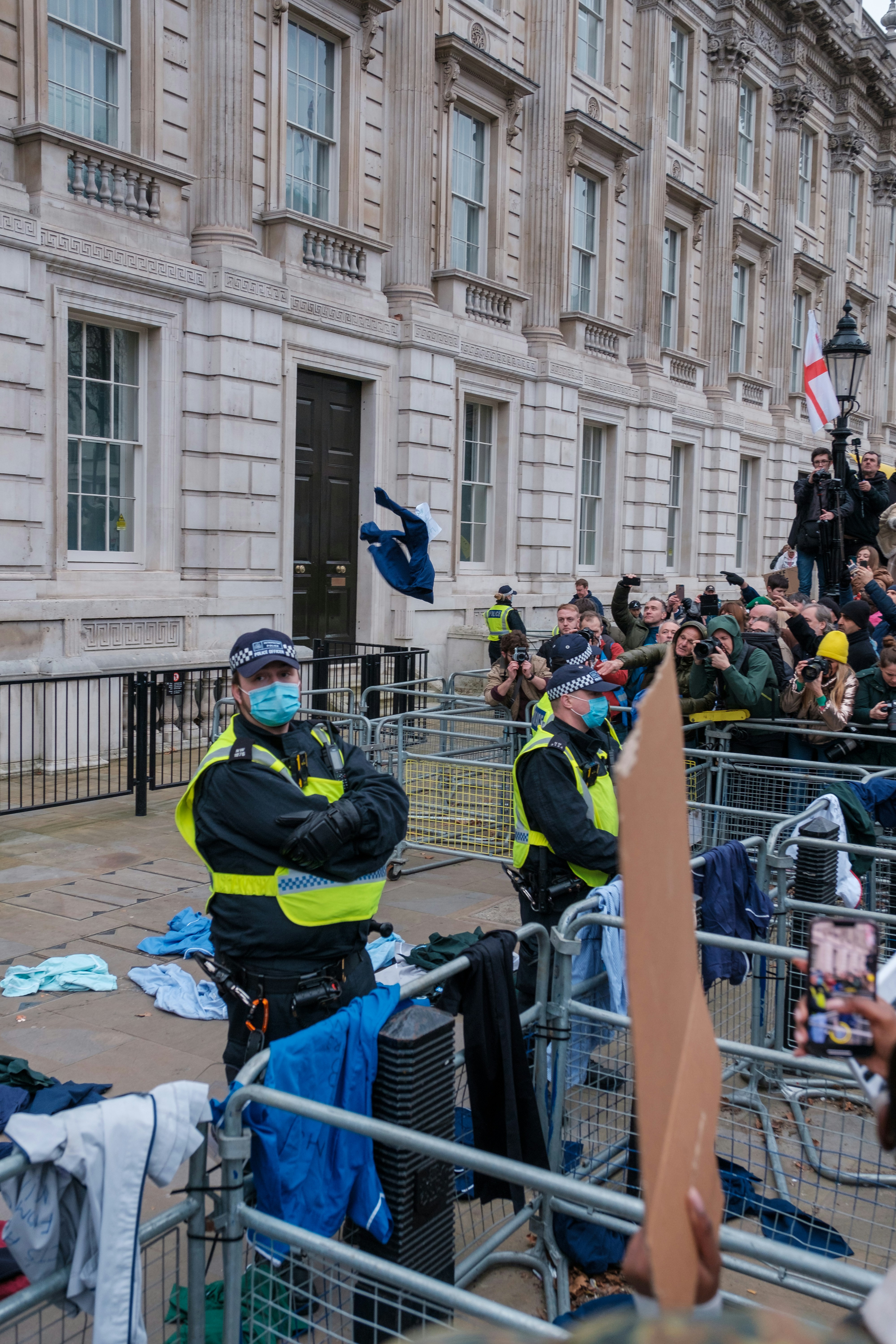 A group of police officers standing next to a crowd of people photo ...