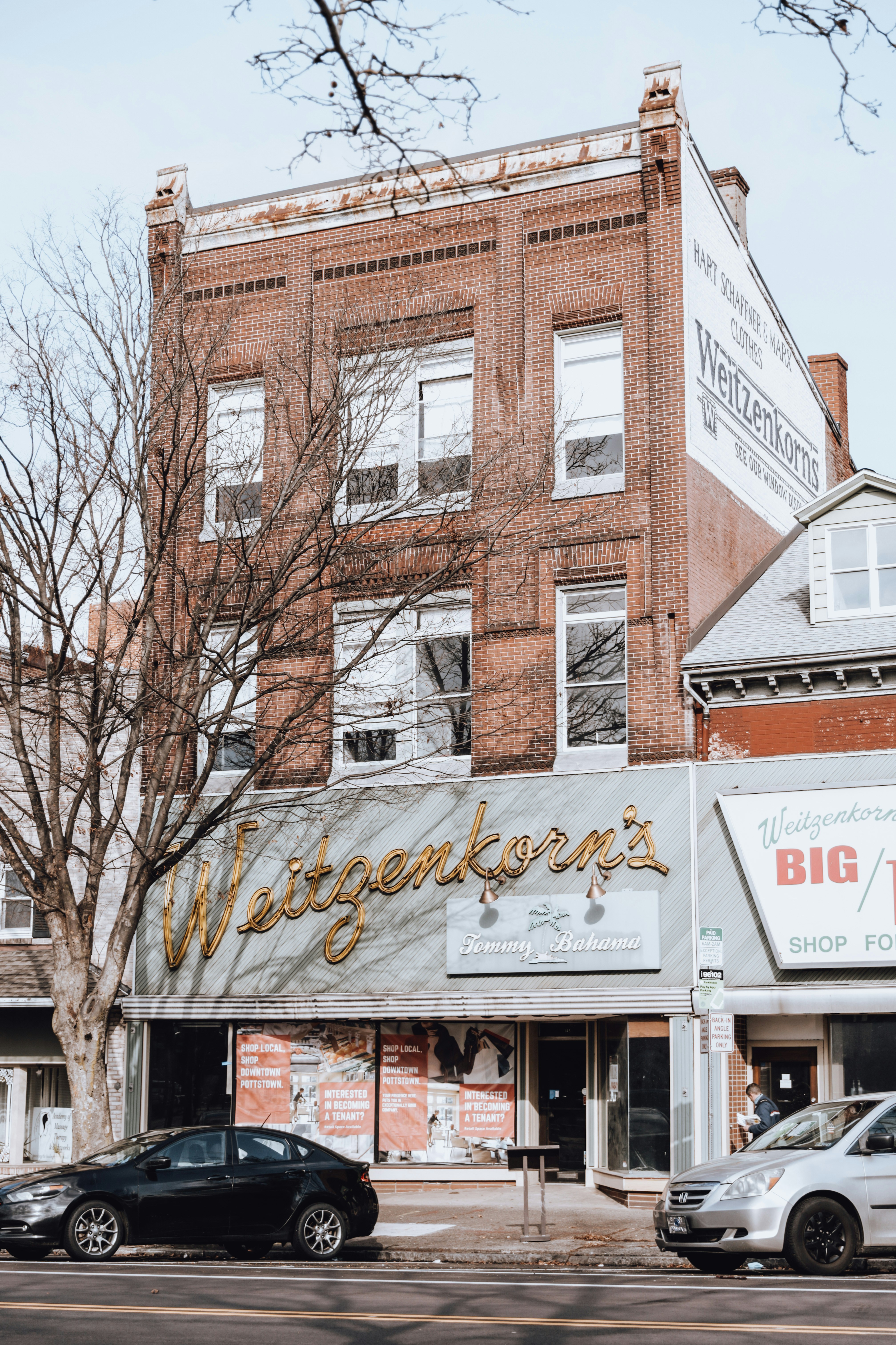 A large brick building with a big sign on the front of it photo – Free ...