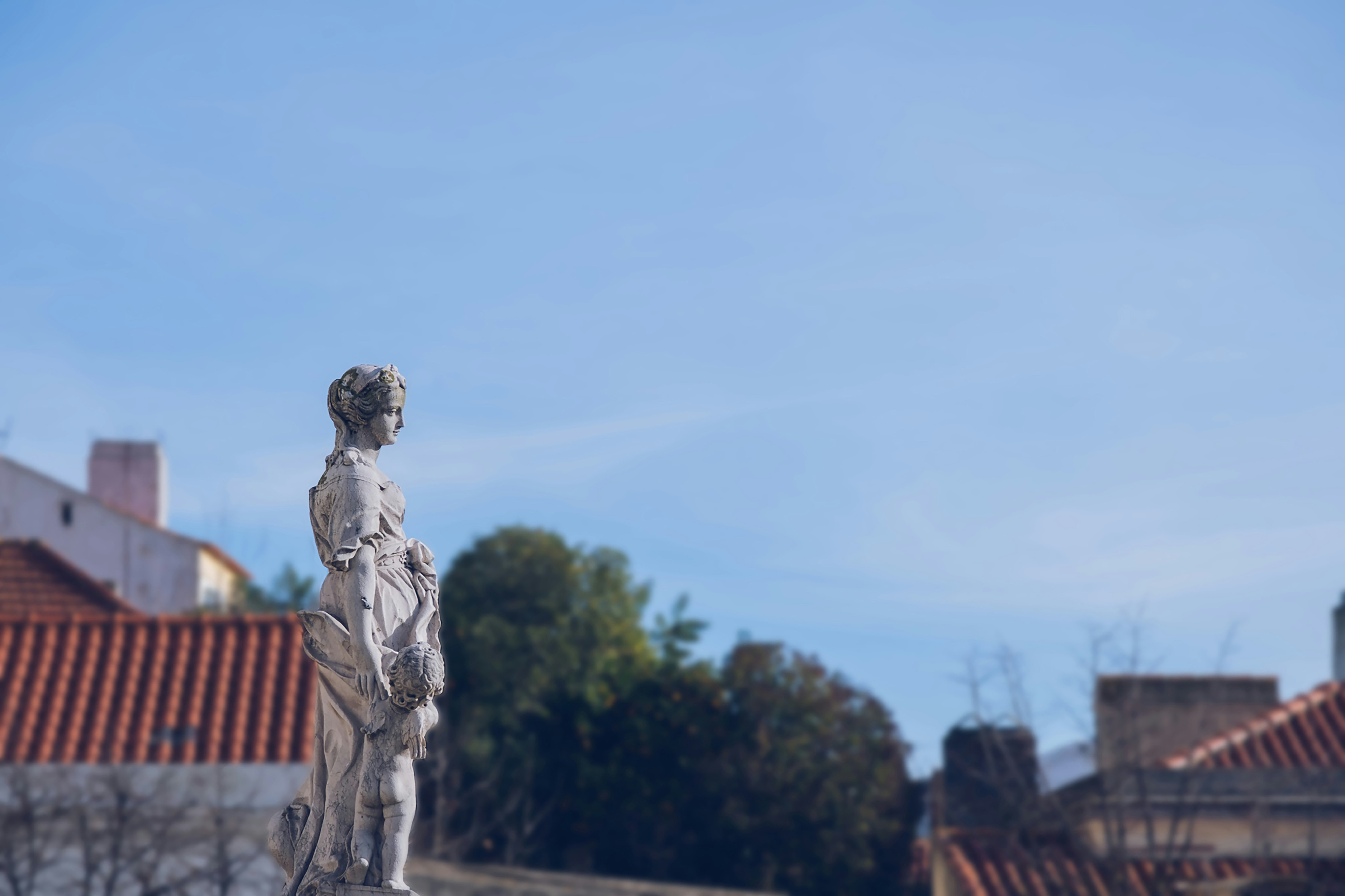 Statue Silhouettes Against a Lisbon Blue Sky