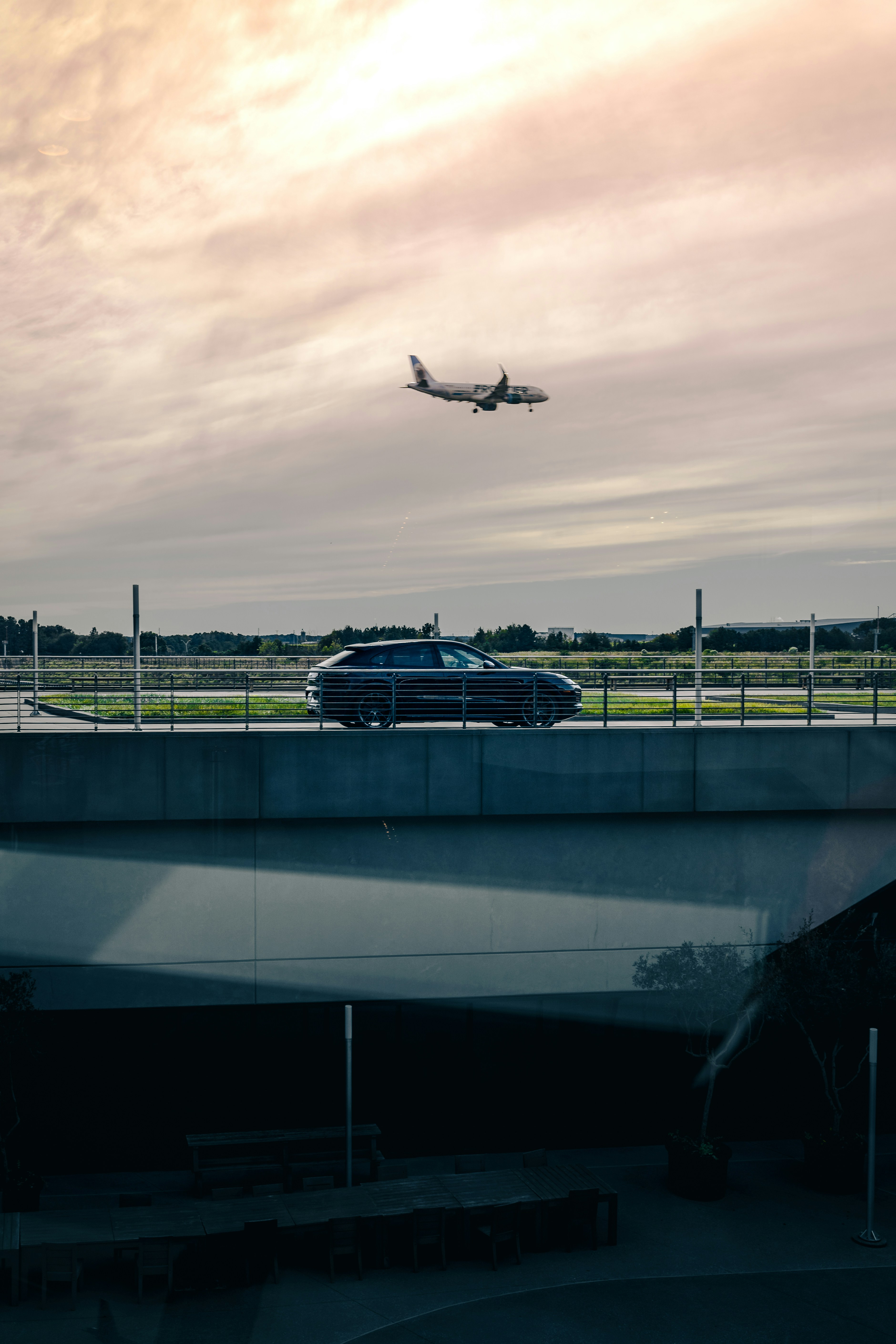 An airplane is flying over a bridge and a car photo – Free Atlanta ...