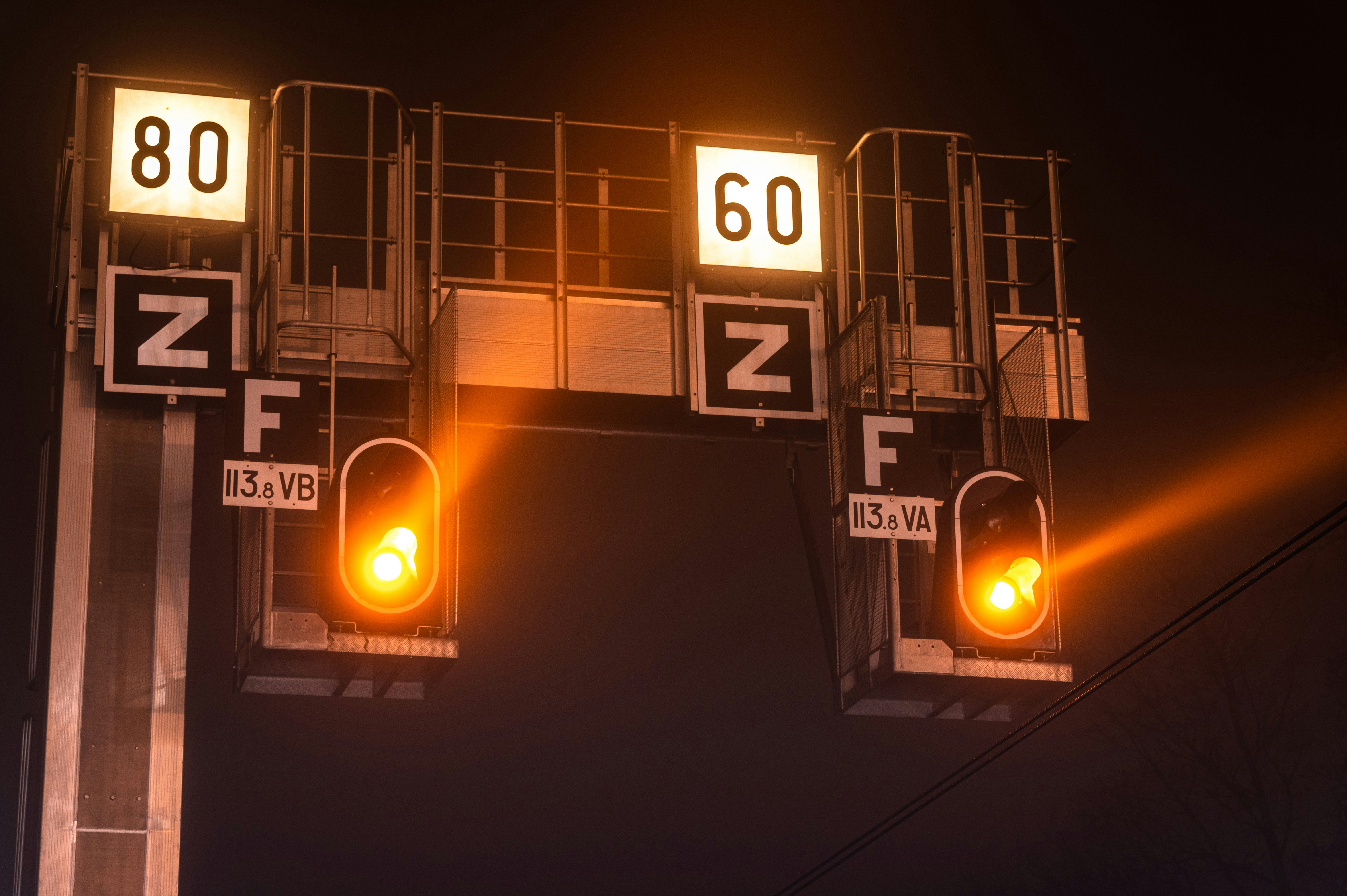 Overhead Signals at Night: Warm Glow on Cold Steel