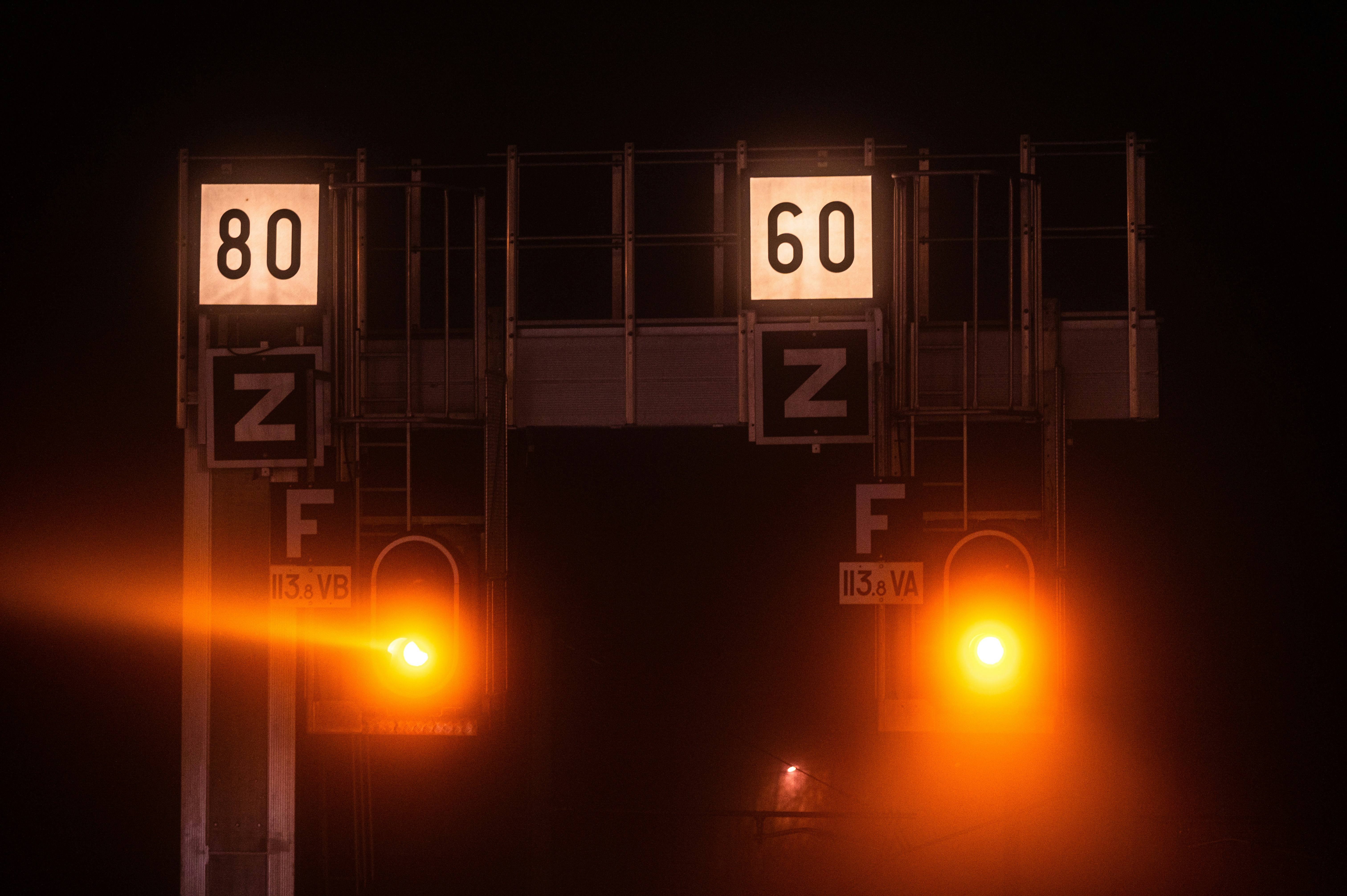 Fogbound Amber Signals Guard the Night Highway
