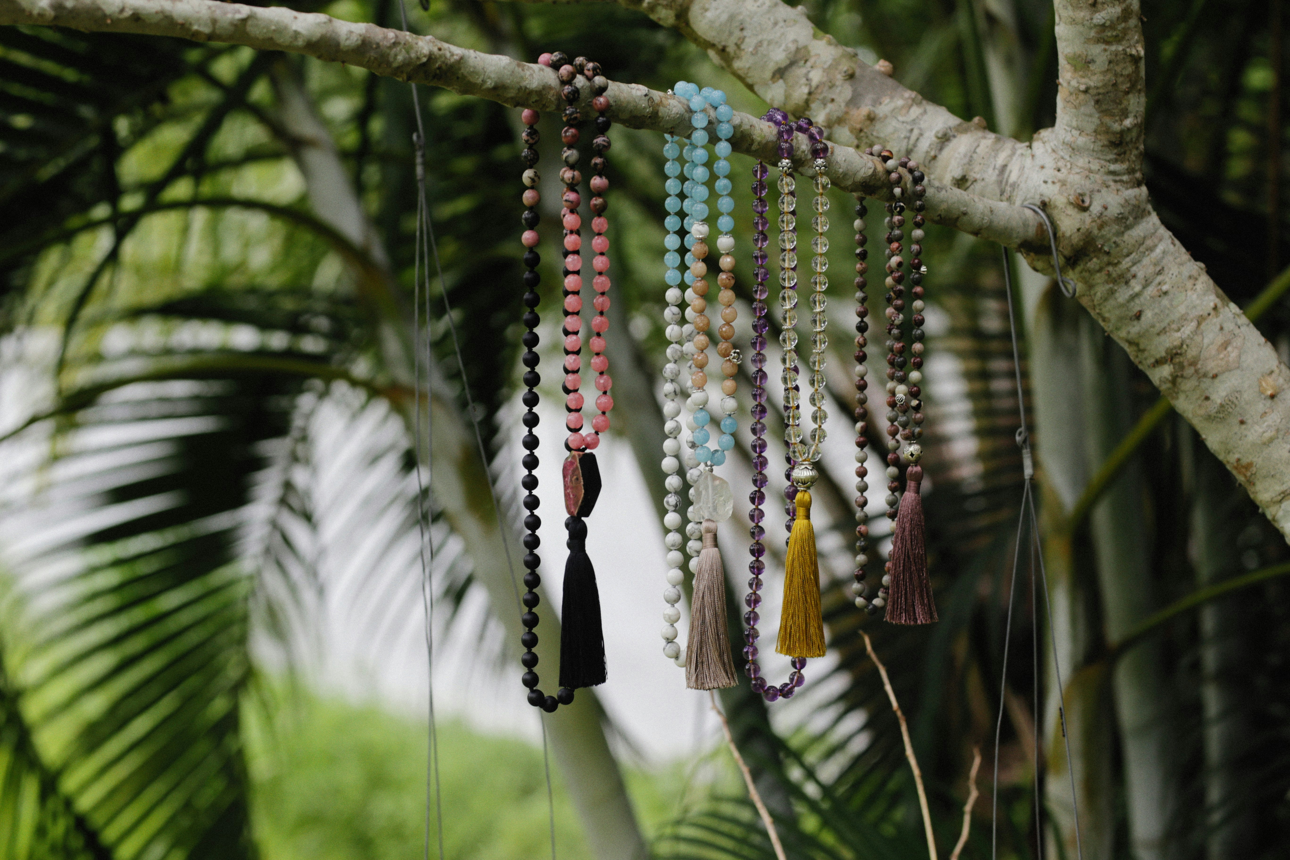 a bunch of beads hanging from a tree