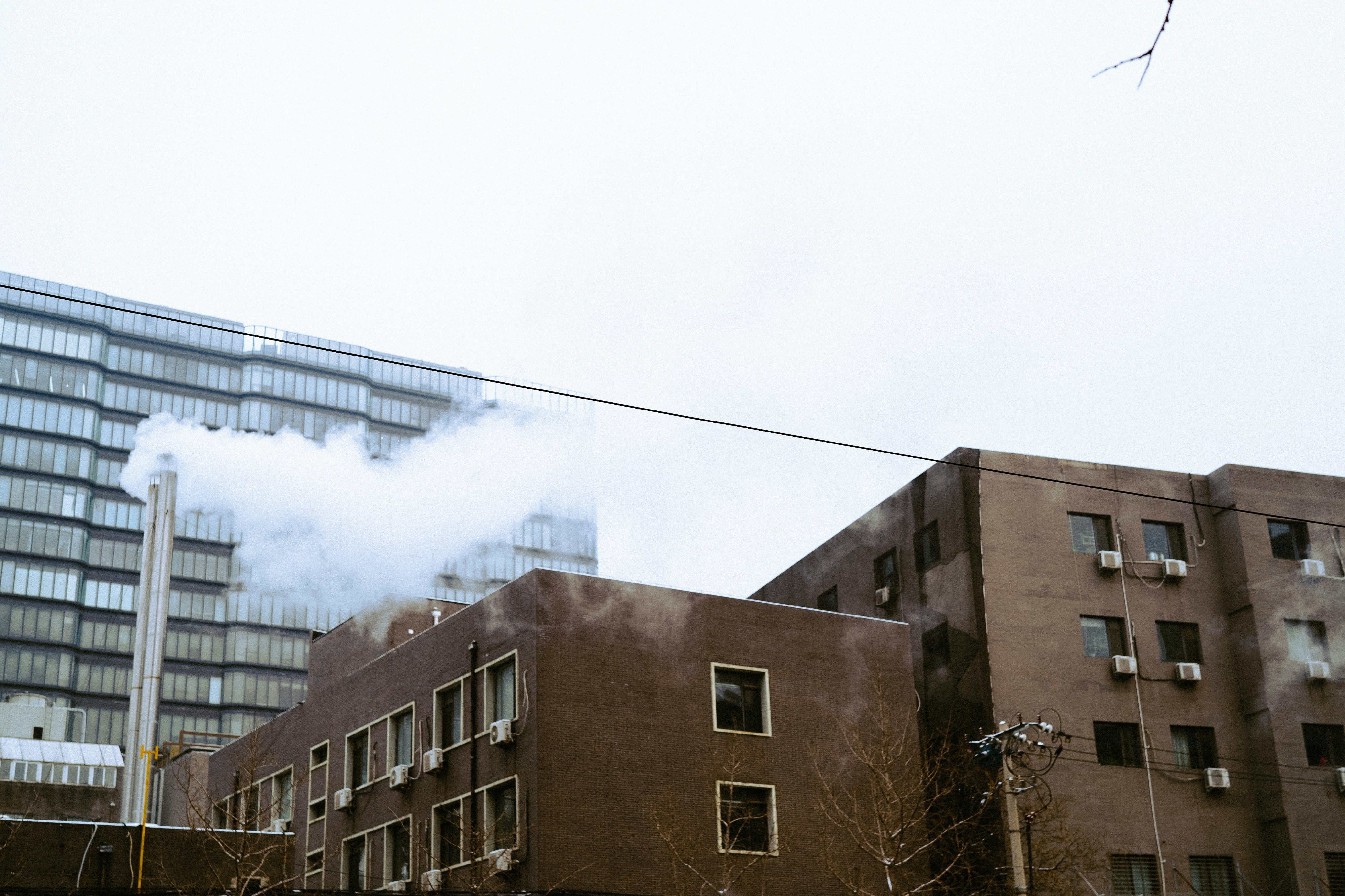 A building with smoke coming out of the windows photo – Free Beijing ...