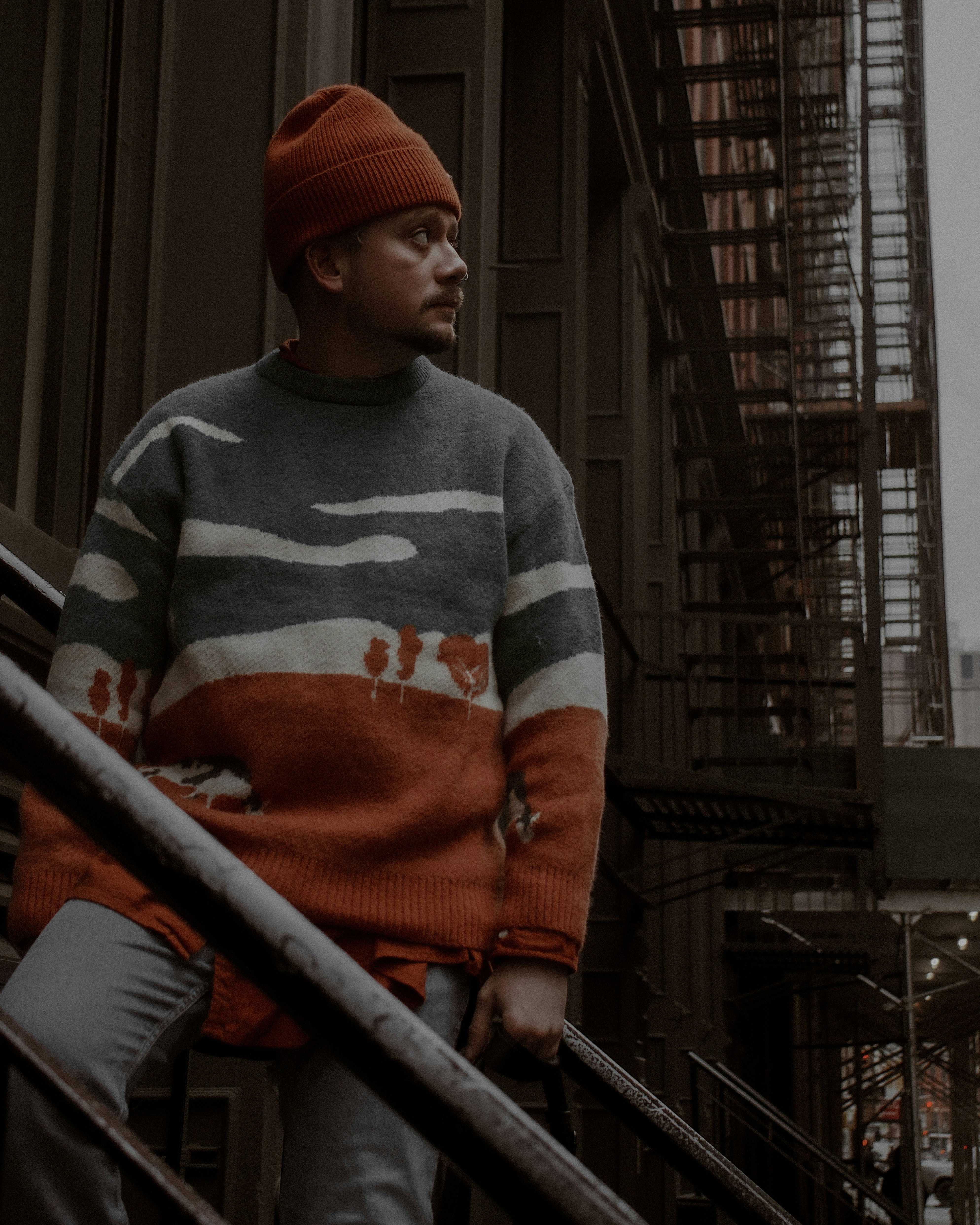 Streetside Contemplation: A Moment on the Fire Escape