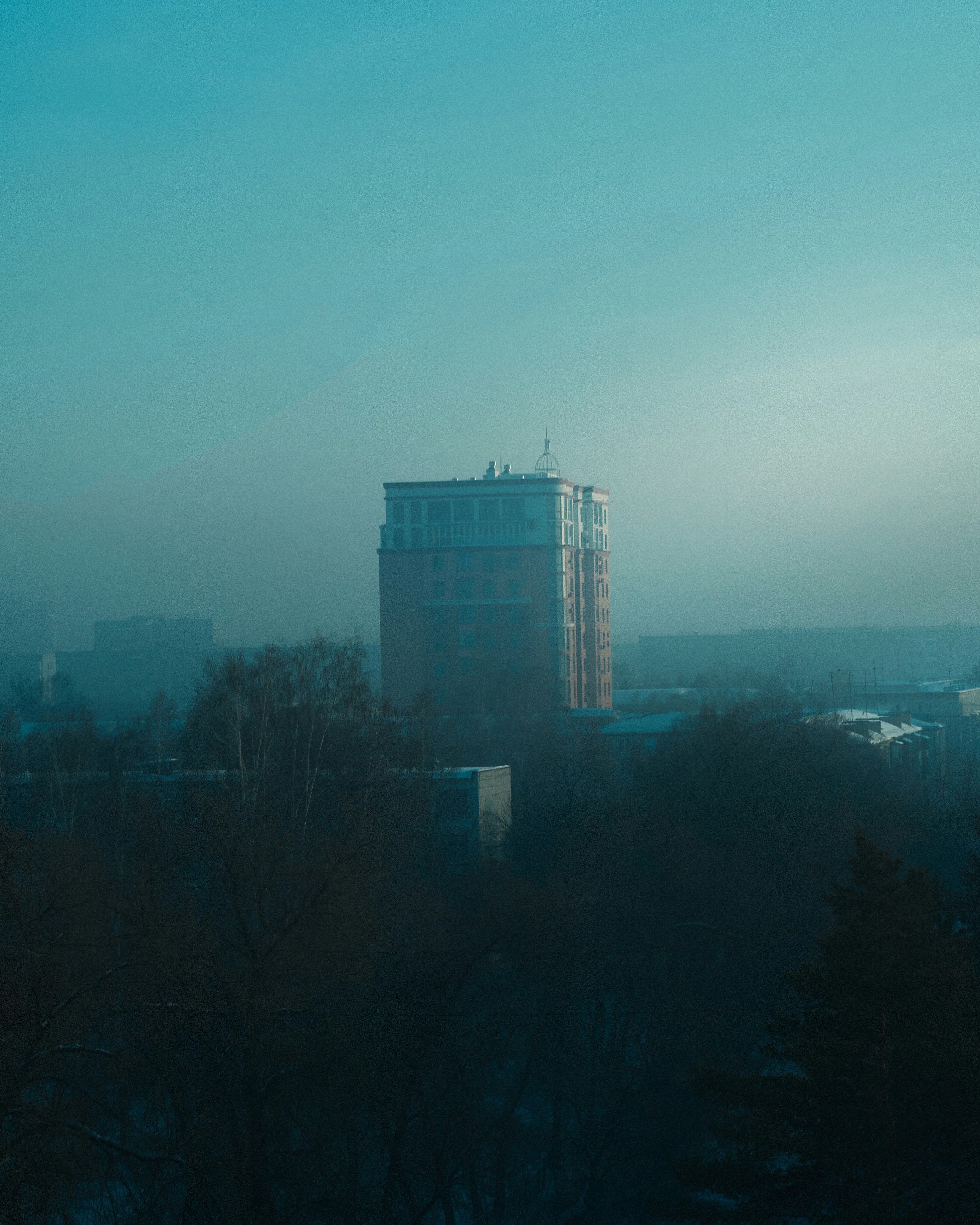 A view of a building from a distance photo – Free Fog Image on Unsplash