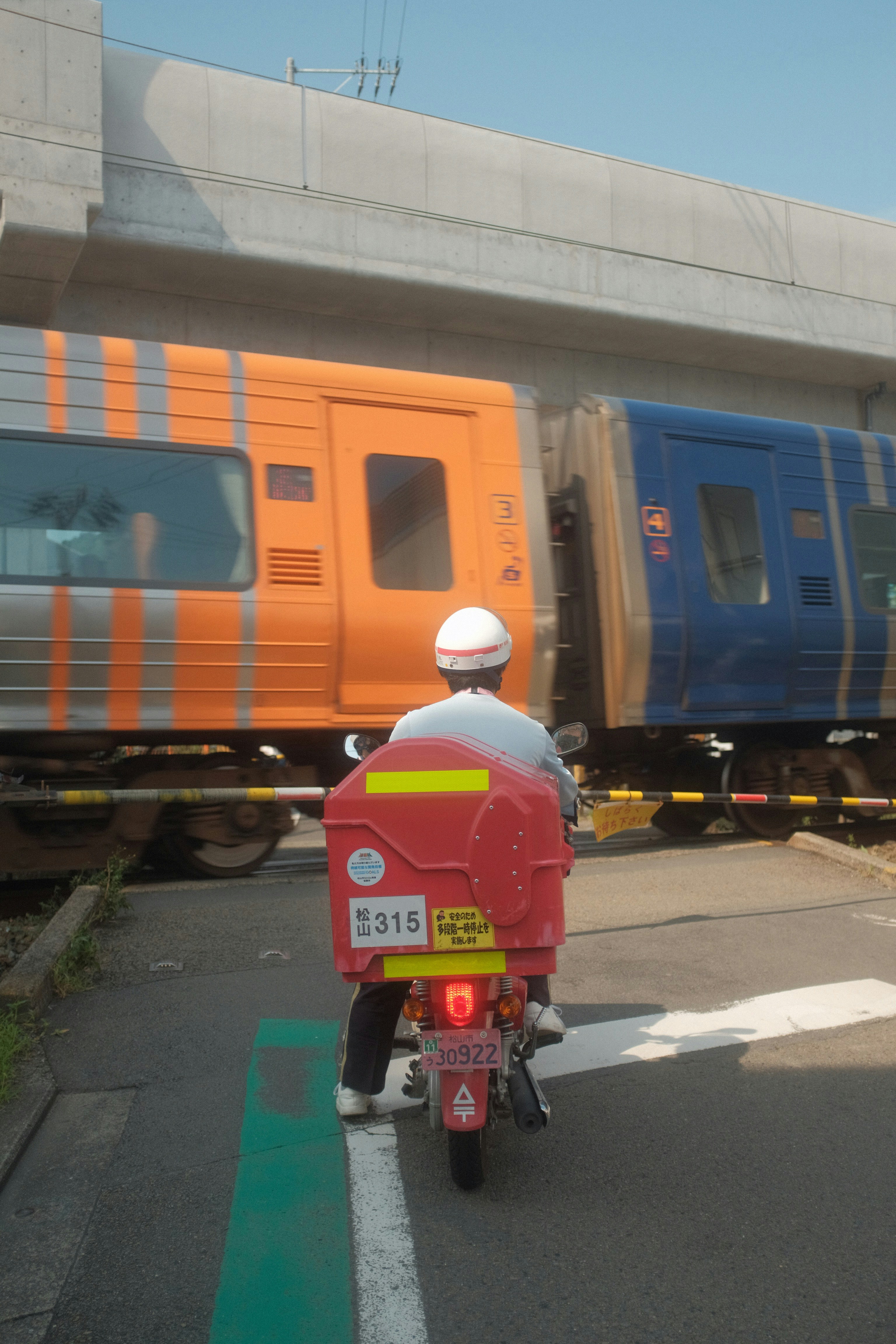 A man riding a motorcycle next to a train photo – Free Train Image on ...