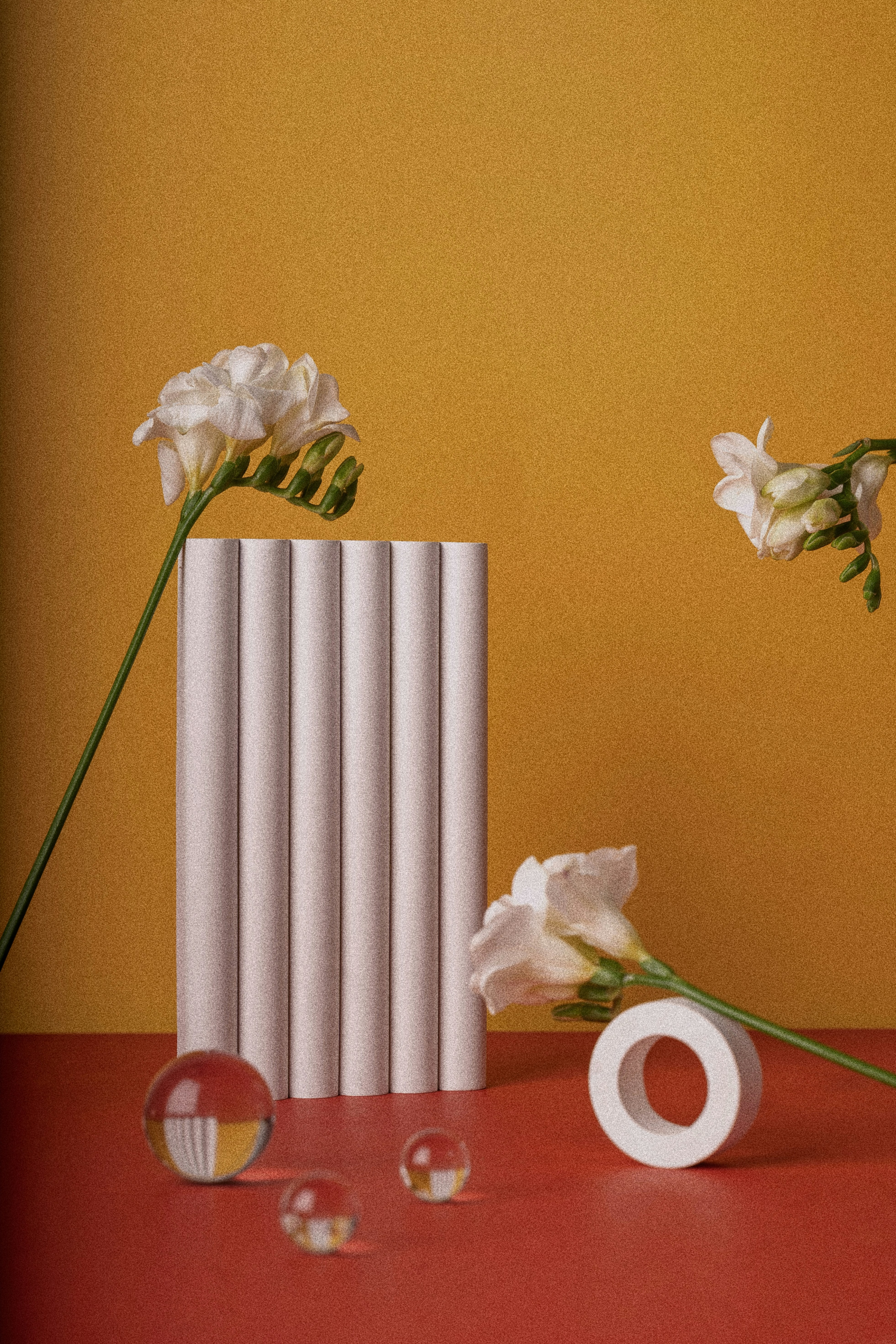 Ribbed Monolith on an Amber Stage: Flowers, Orbs, and a White Ring