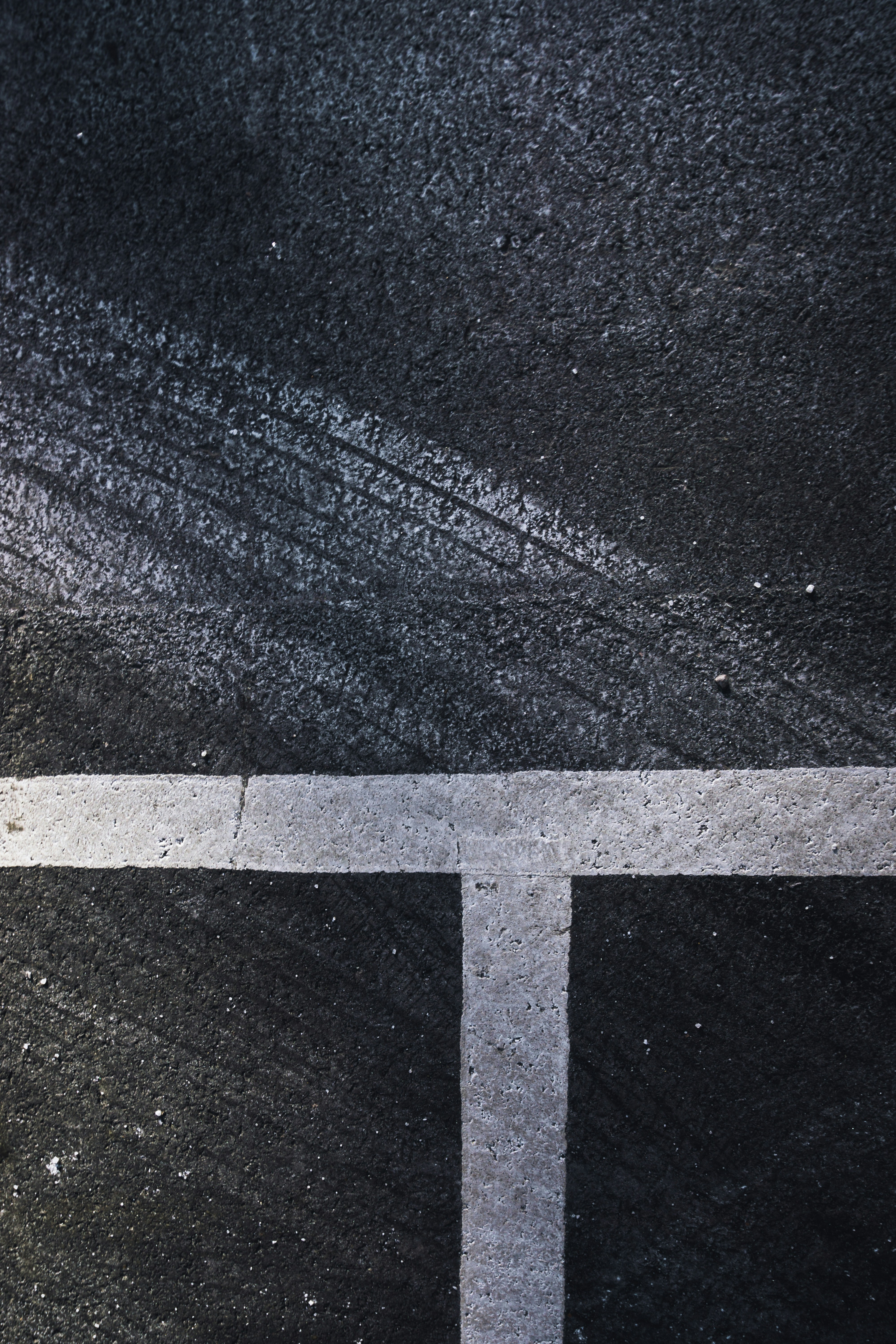 T-Intersection of White Lines on Weathered Asphalt