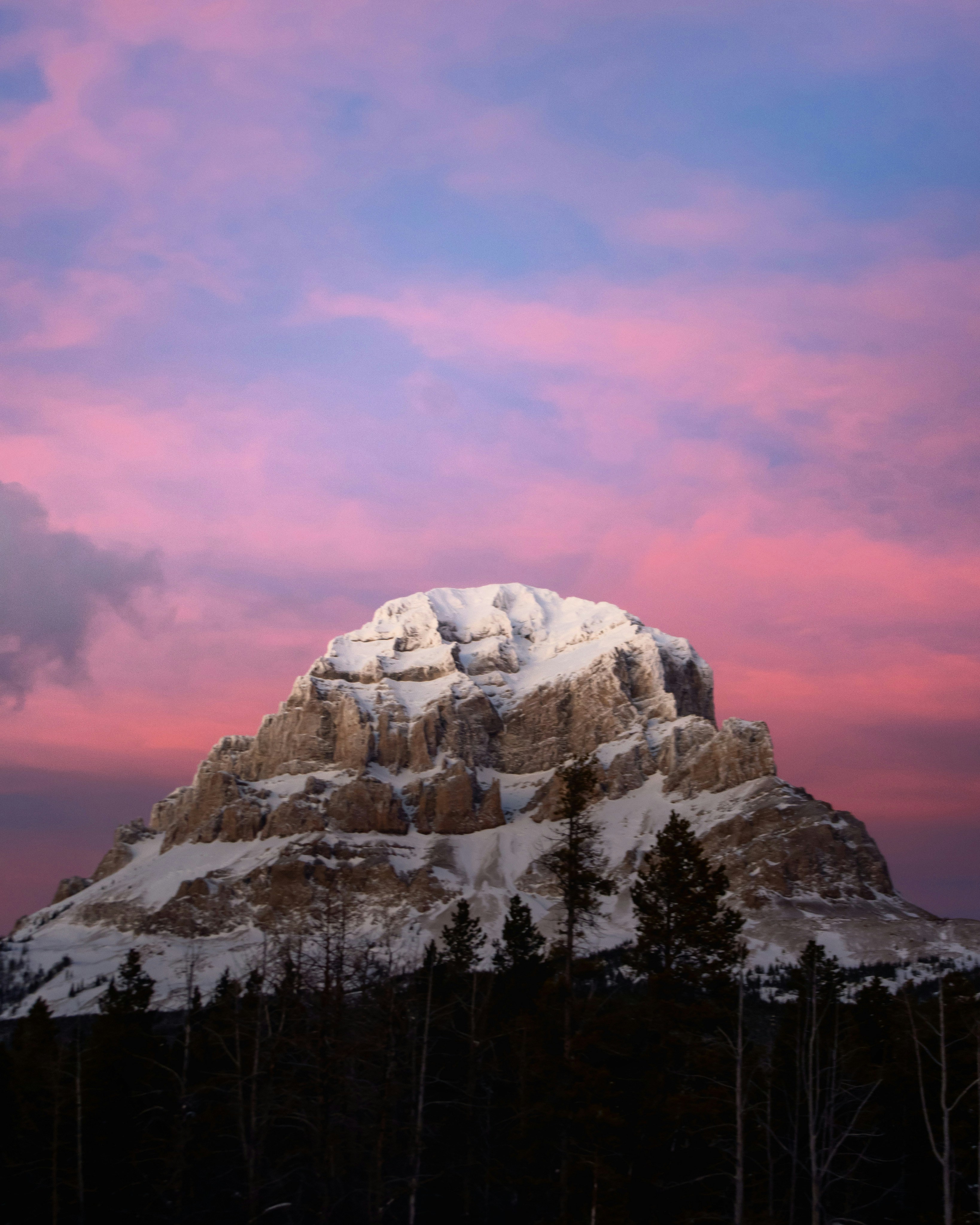 Rose-Glow Summit: Snow-Crowned Peak Beneath a Dusk Sky