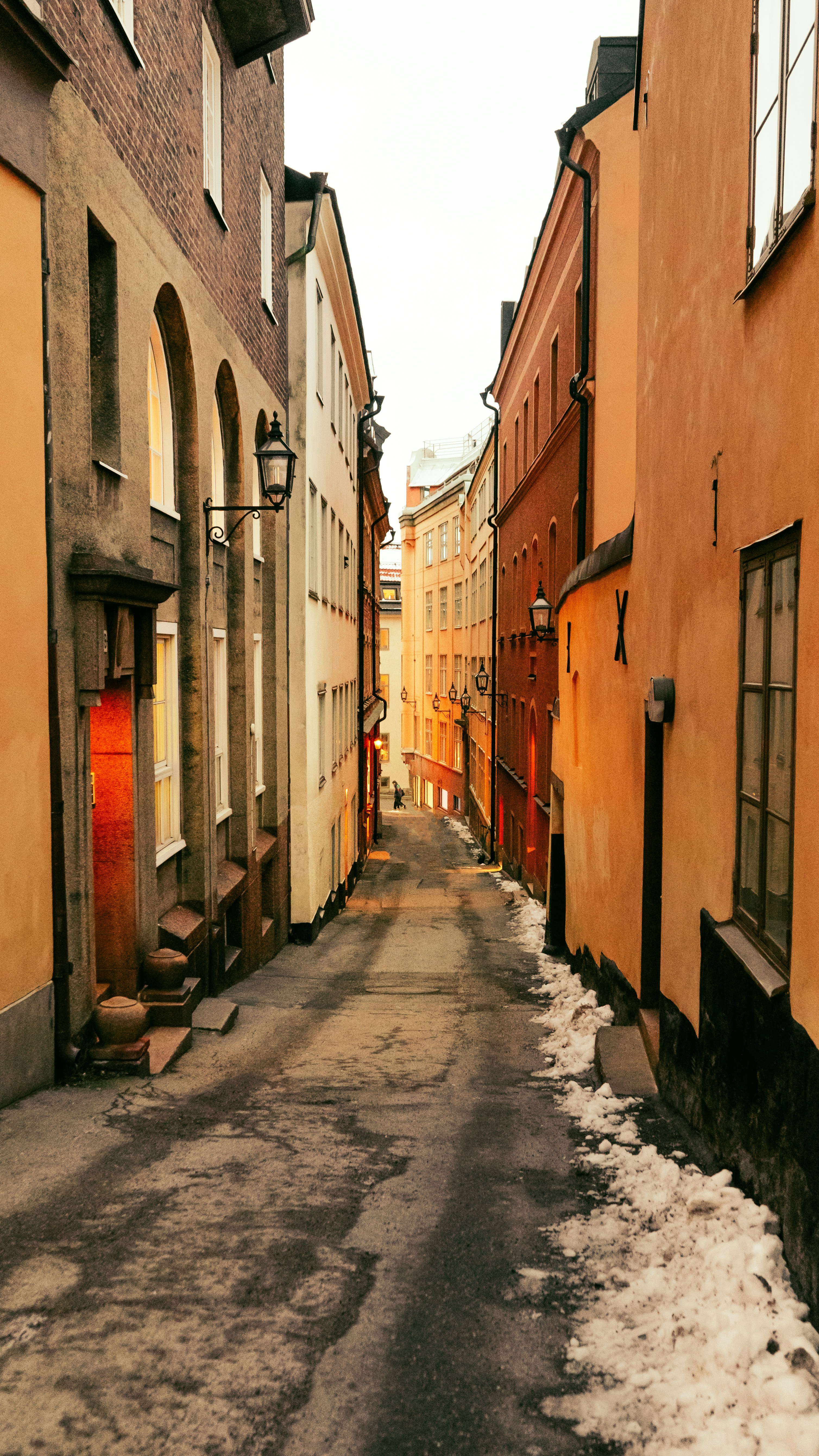 A narrow city street lined with buildings on the side of a building ...