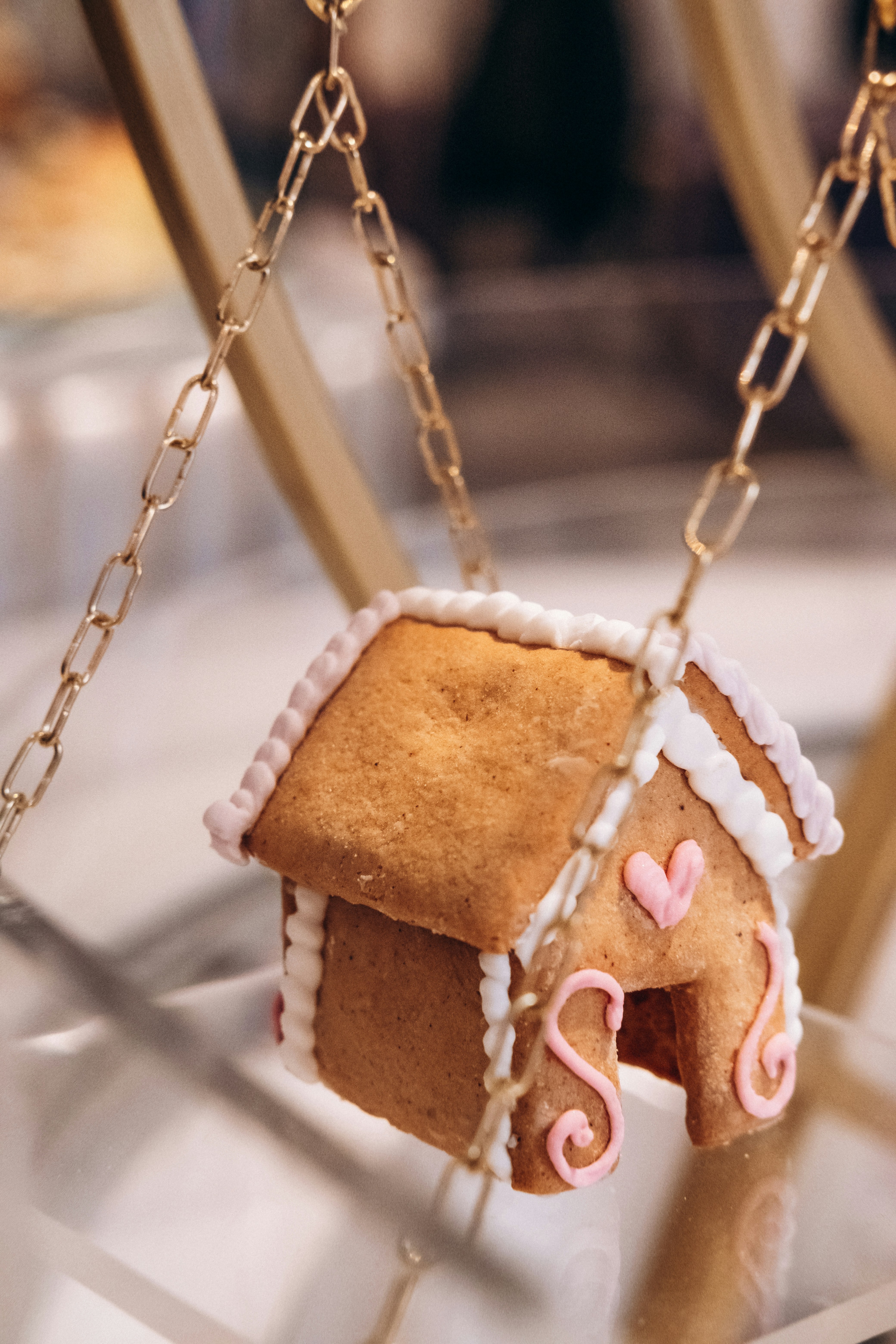A close up of a gingerbread house on a chain photo – Free Biscuit Image ...