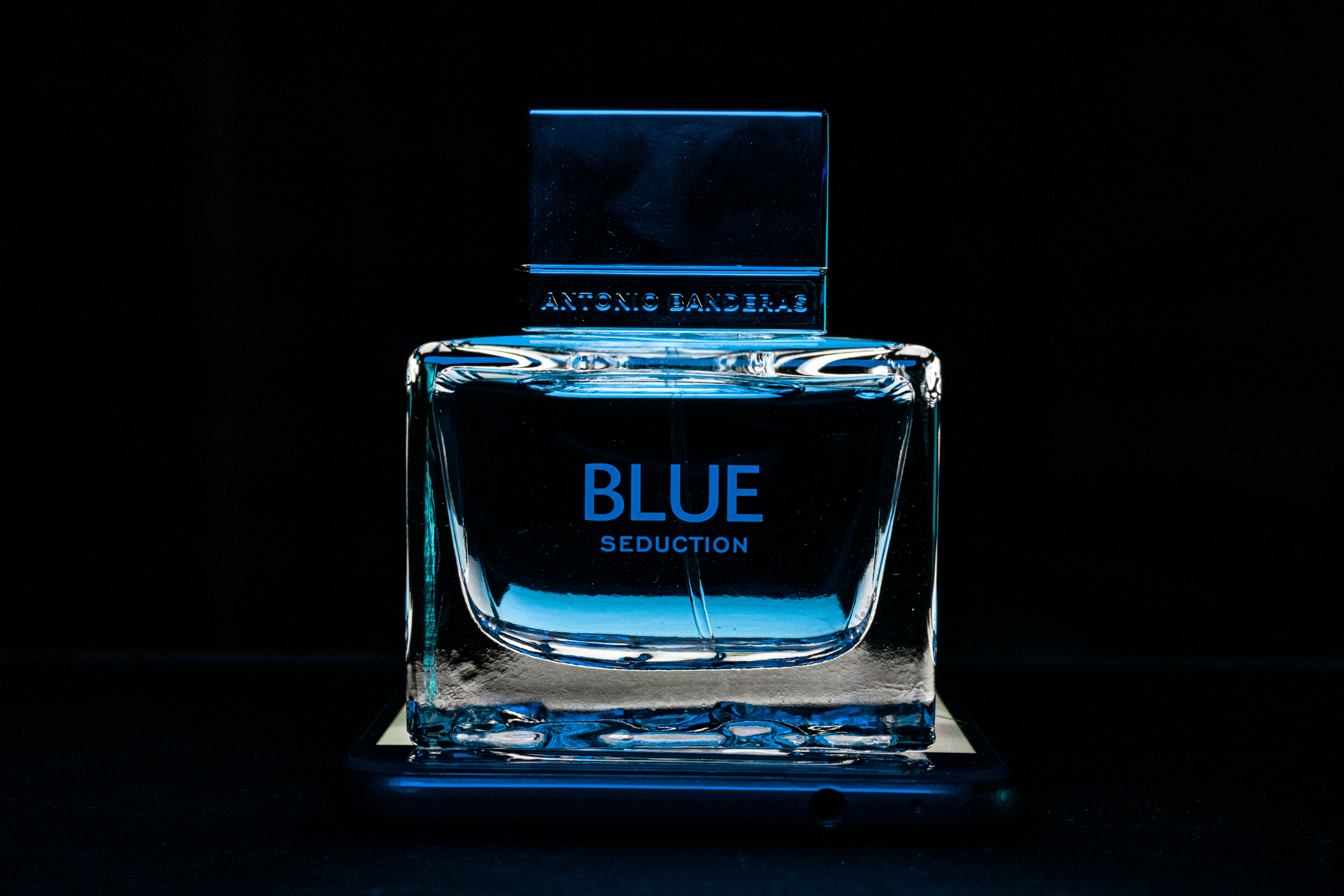 Blue Seduction in Crystal: Velvet-Lit Studio Portrait of a Perfume Bottle