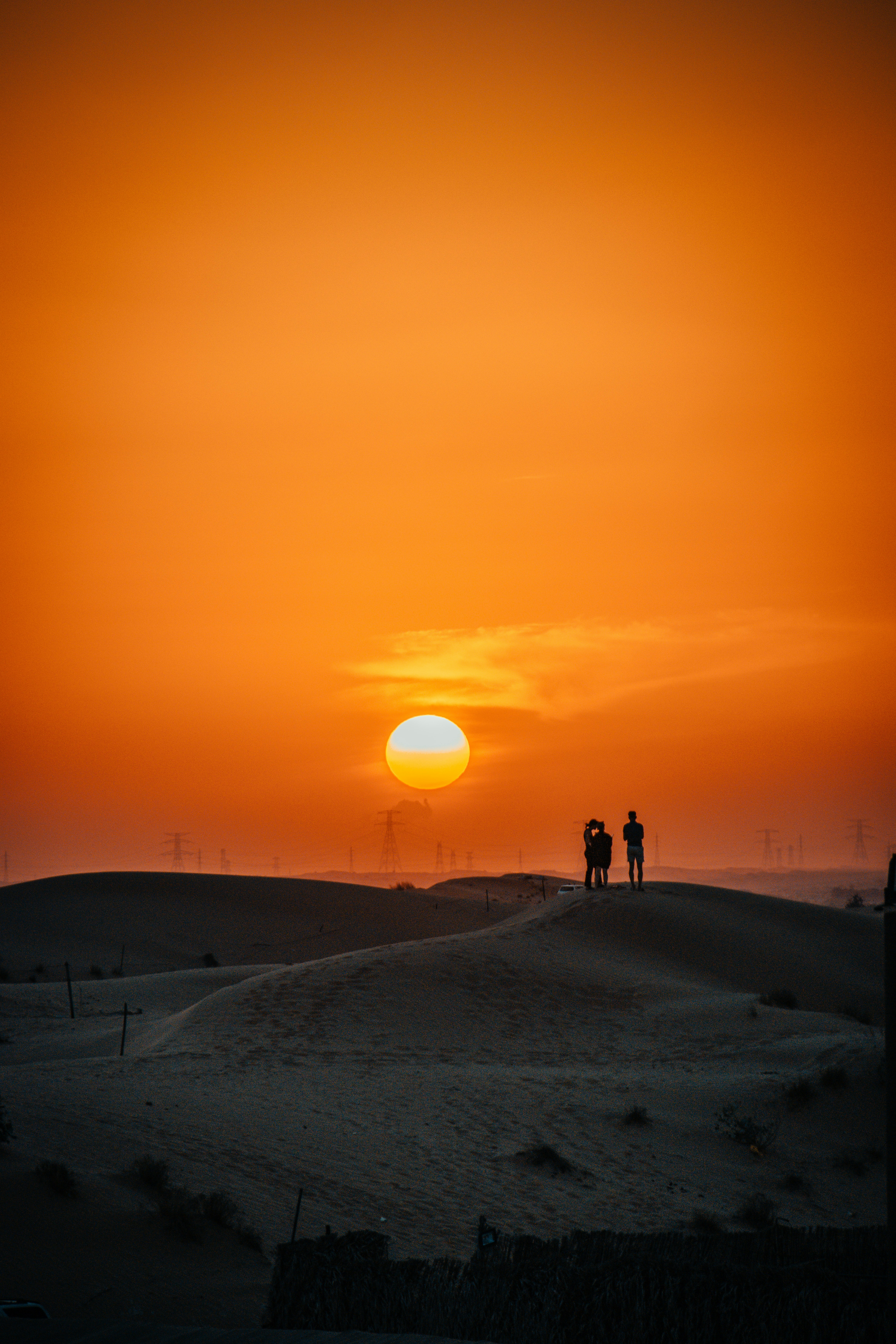 Sunset Crossing on the Dune Crest: Two Silhouettes at the Horizon