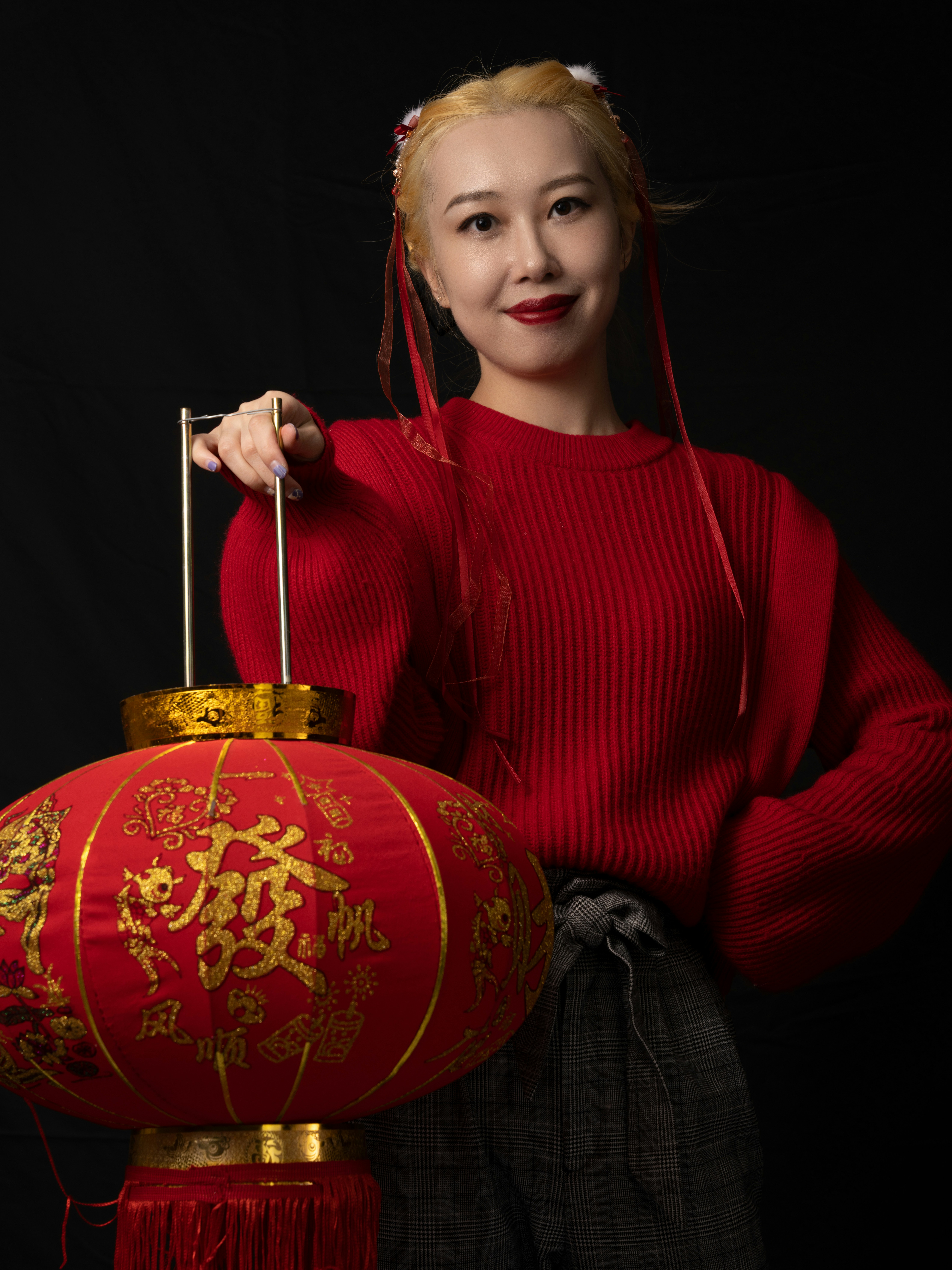 A woman in a red sweater holding a red lantern photo – Free Human Image ...