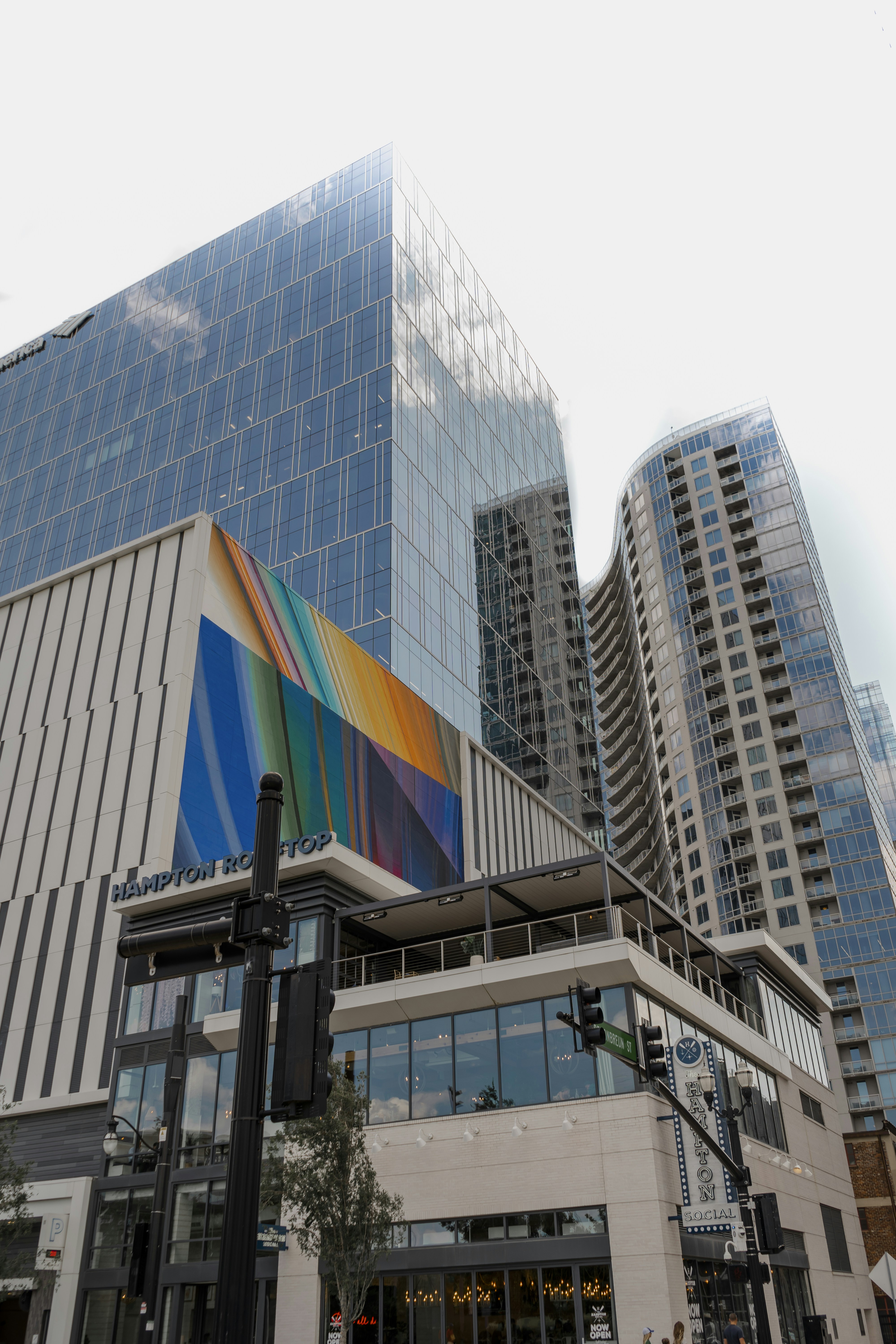A tall building with a colorful mural on it's side photo – Free ...