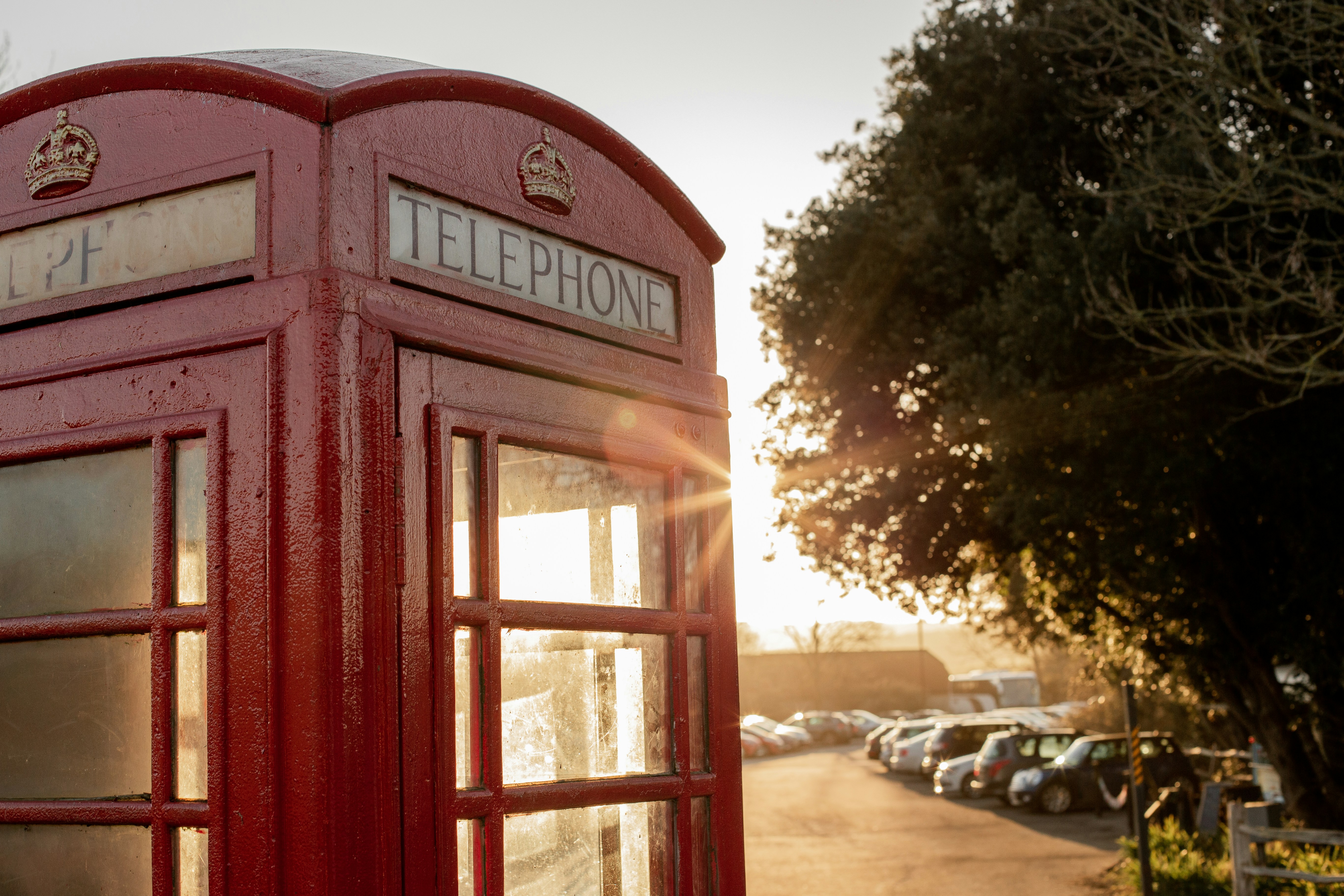 Sunset Glow Embraces a Red British Telephone Booth