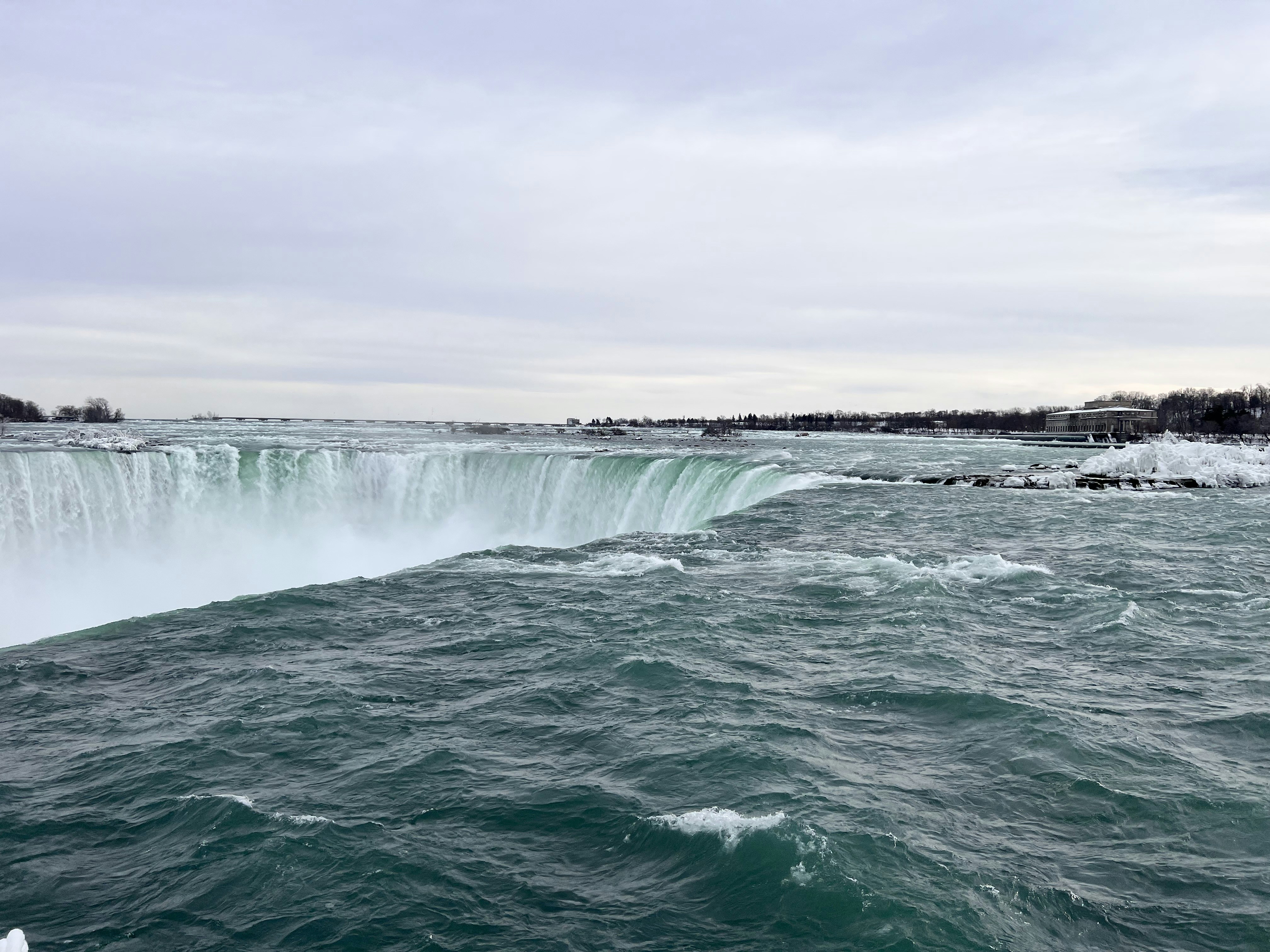 Grey Curtain Over Teal Waters: Edge of the Falls