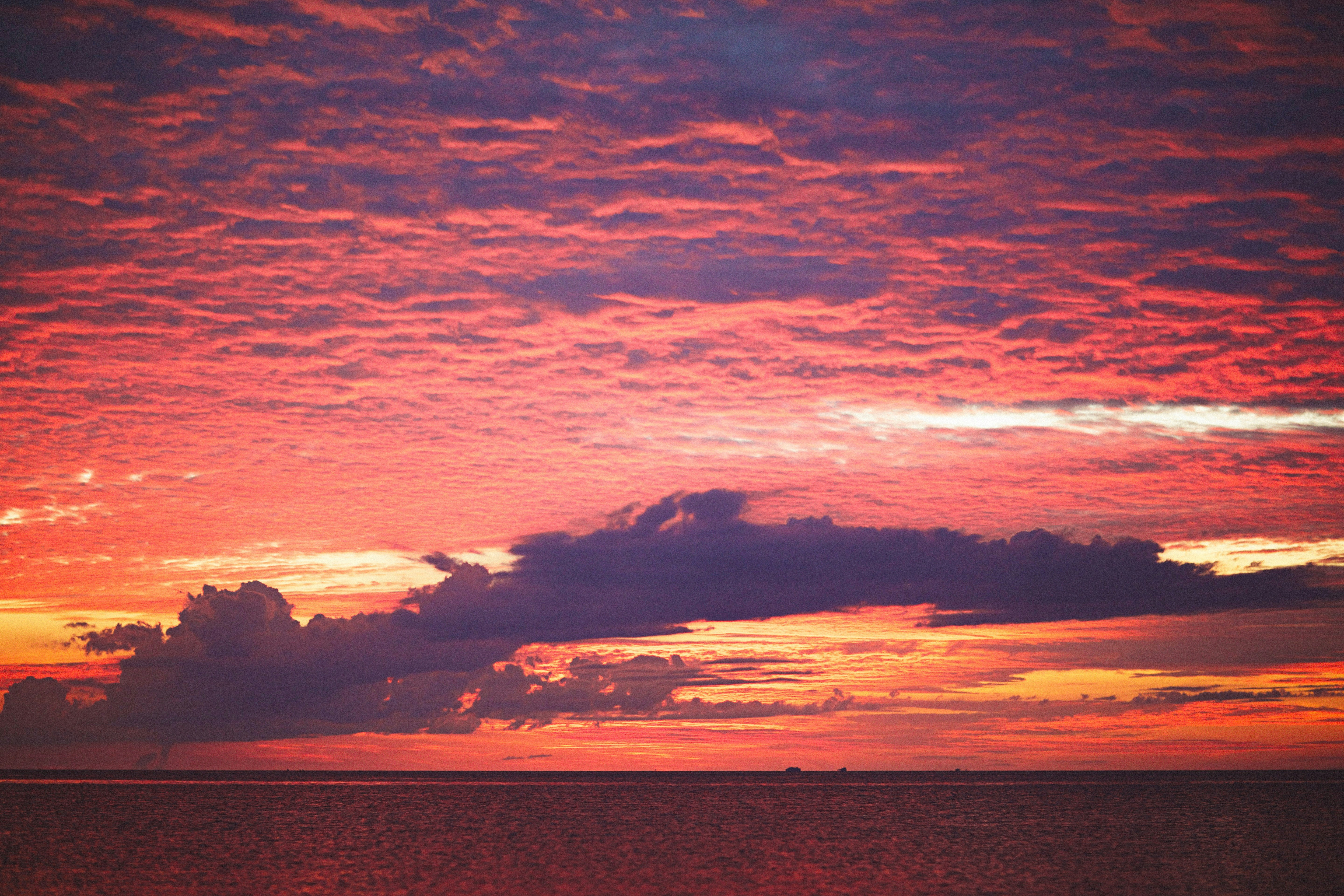 A red and purple sunset over the ocean photo – Free Nature Image on ...