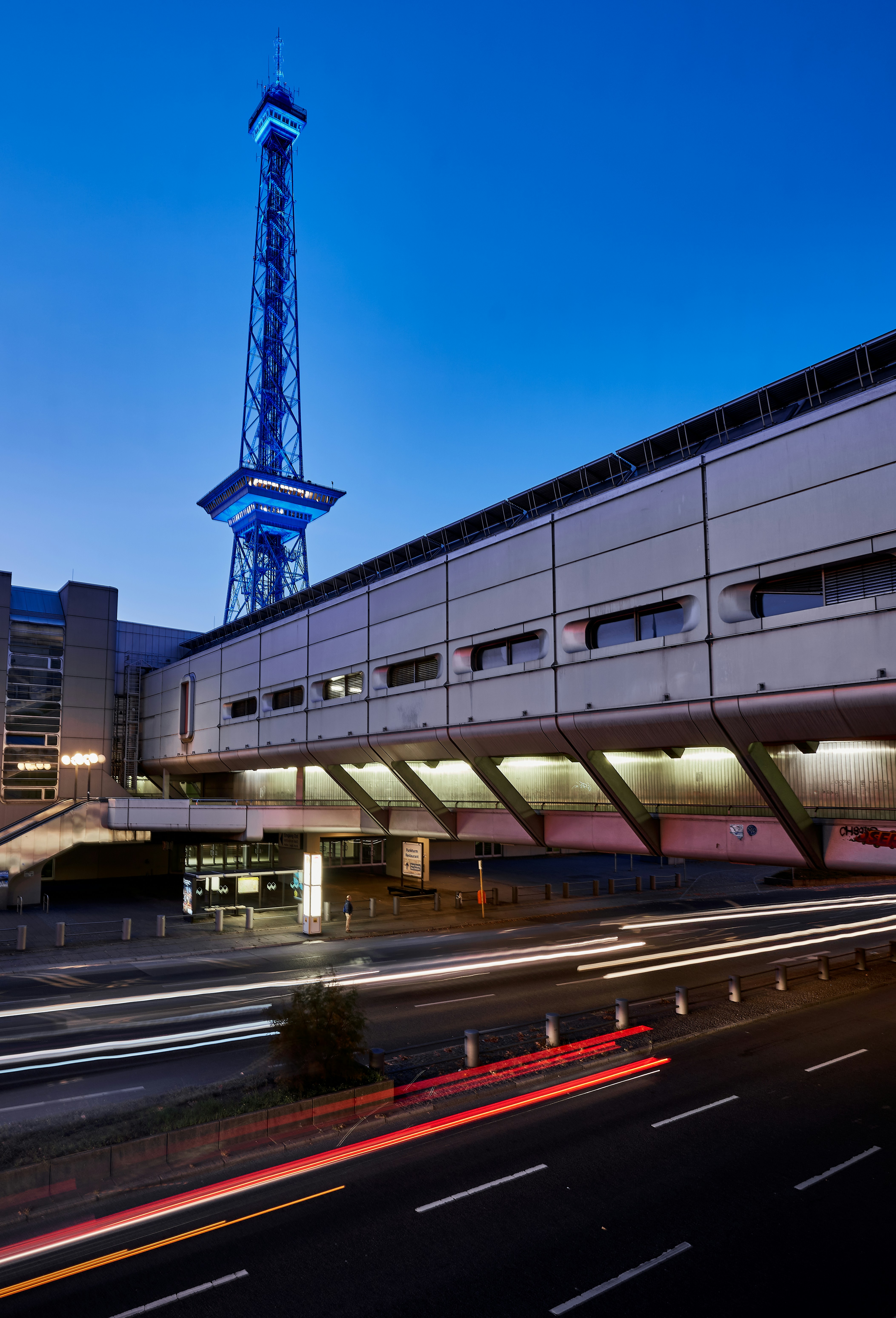 Blue Hour Tower Above the Transit Spine, Framed by Light Trails