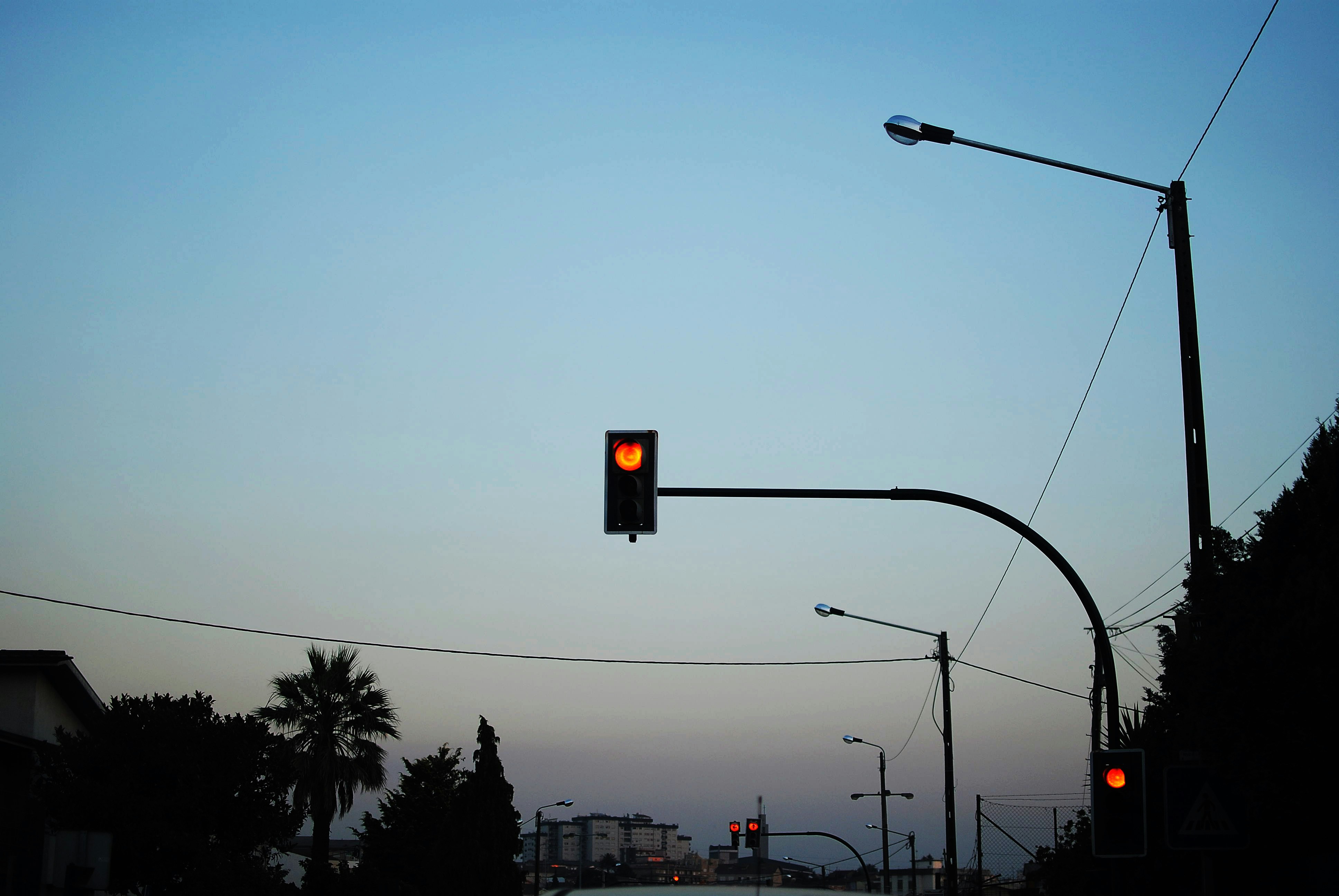 A traffic light hanging over a city street photo – Free Traffic light ...