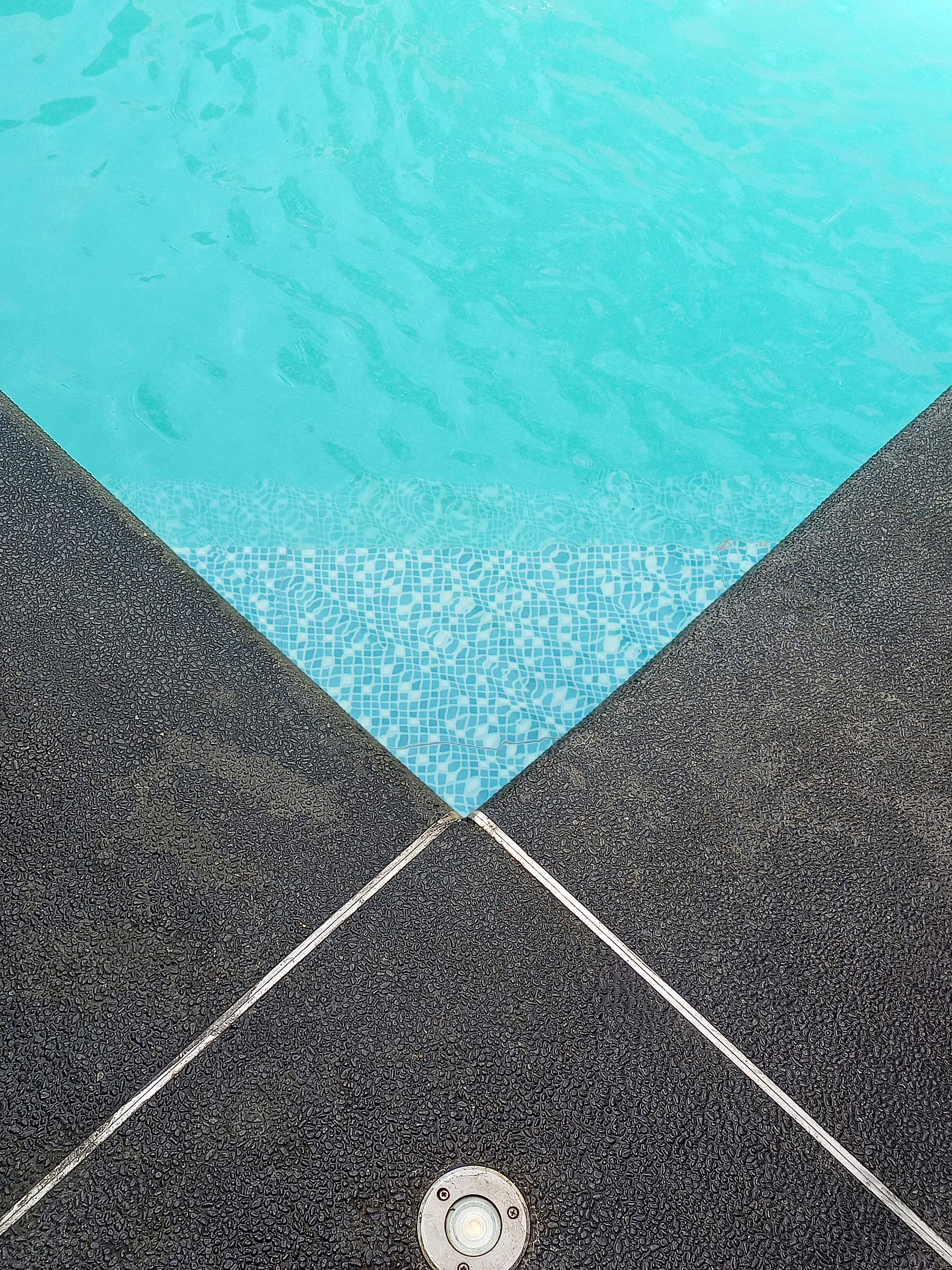 A blue swimming pool with a tile floor next to it photo – Free Blue ...