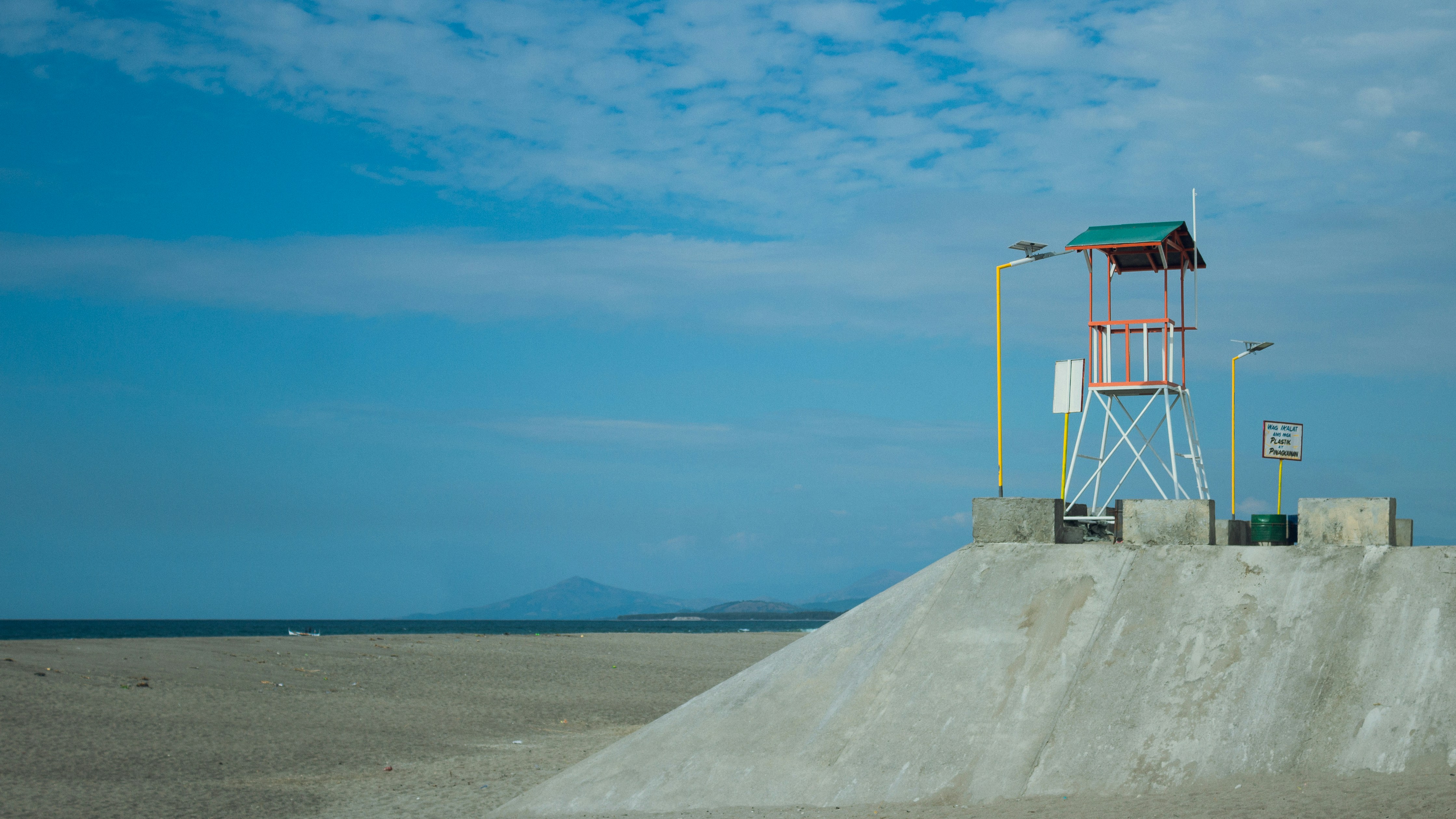 A lifeguard tower sitting on top of a cement wall photo – Free Outdoors ...