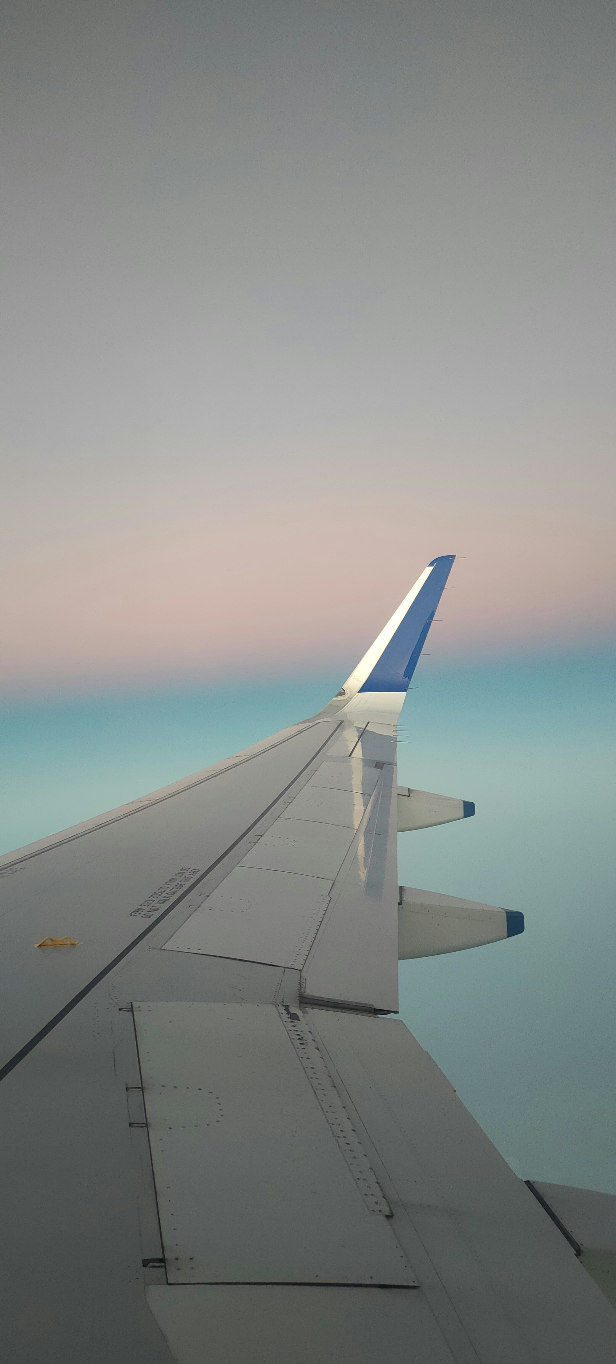 a view of the wing of an airplane in the sky