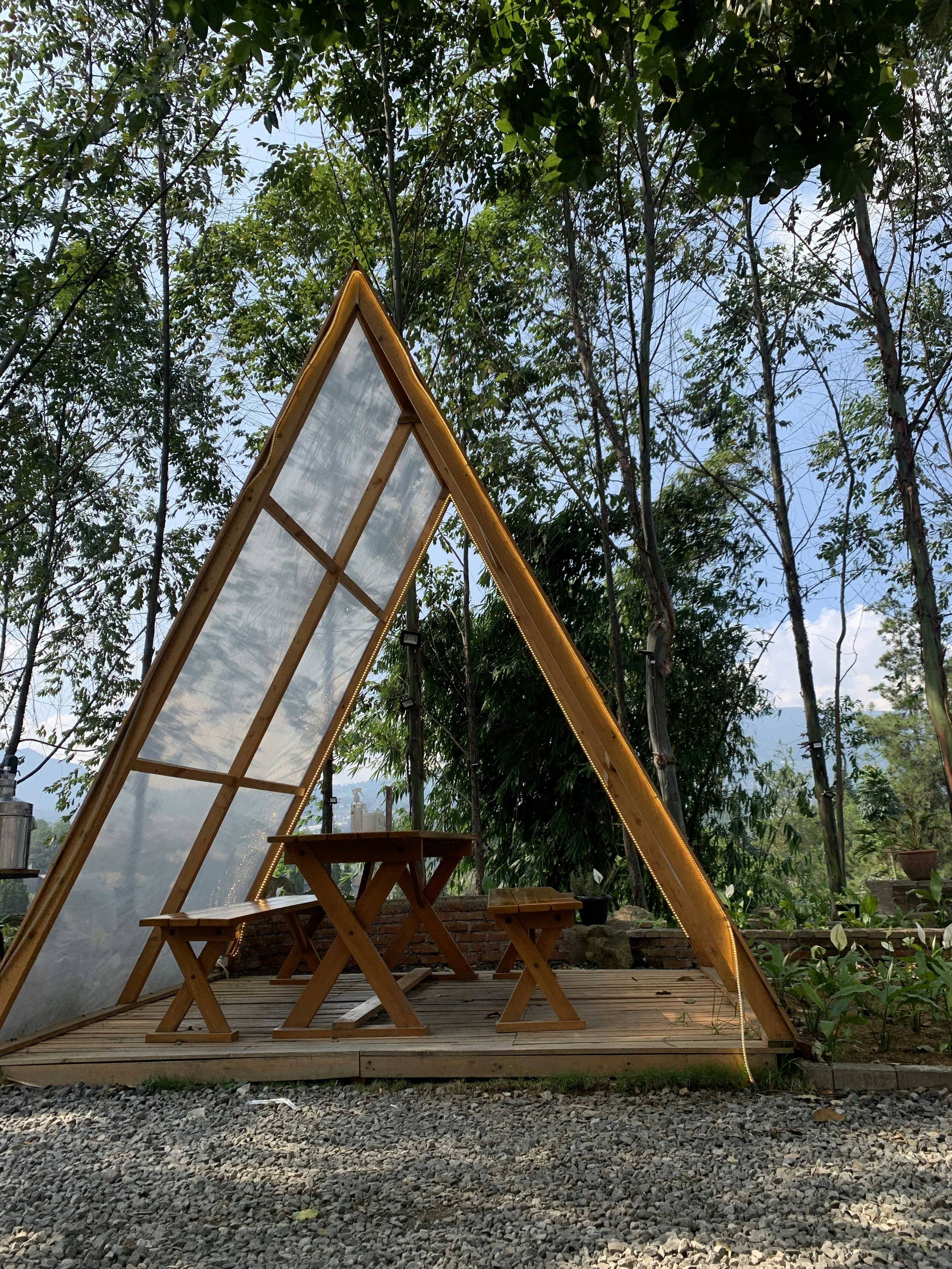 A wooden structure with a picnic table inside of it photo – Free Wood ...