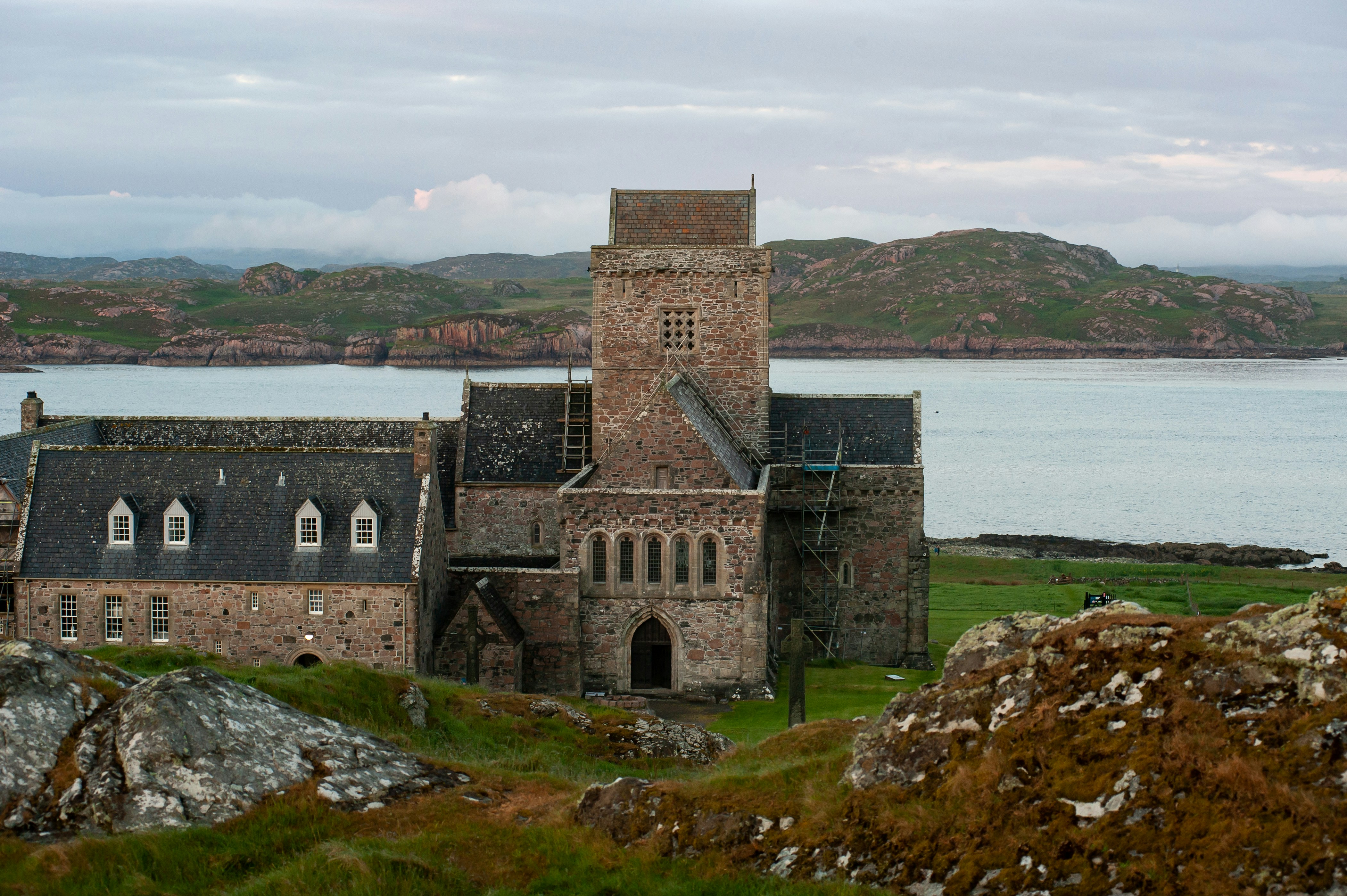 A large building with a tower near a body of water photo – Free Isle of ...
