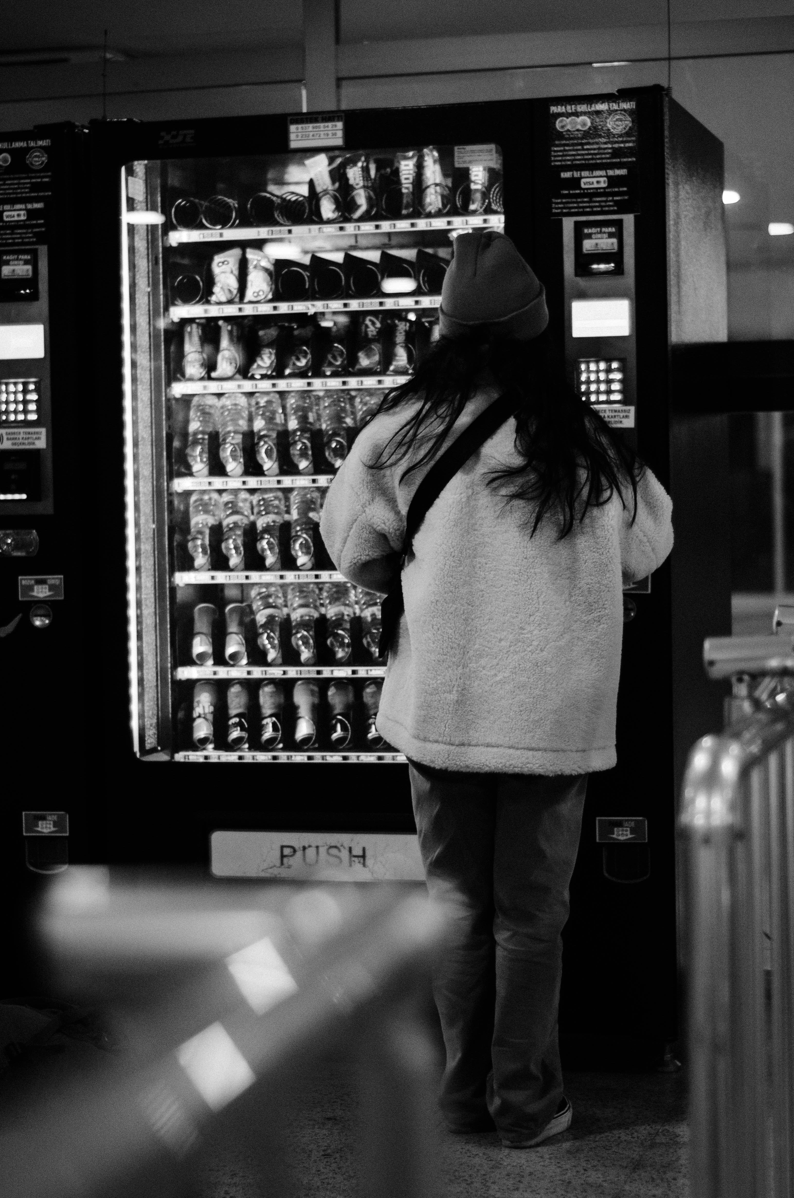Solitary Shopper Before a Wall of Sneakers
