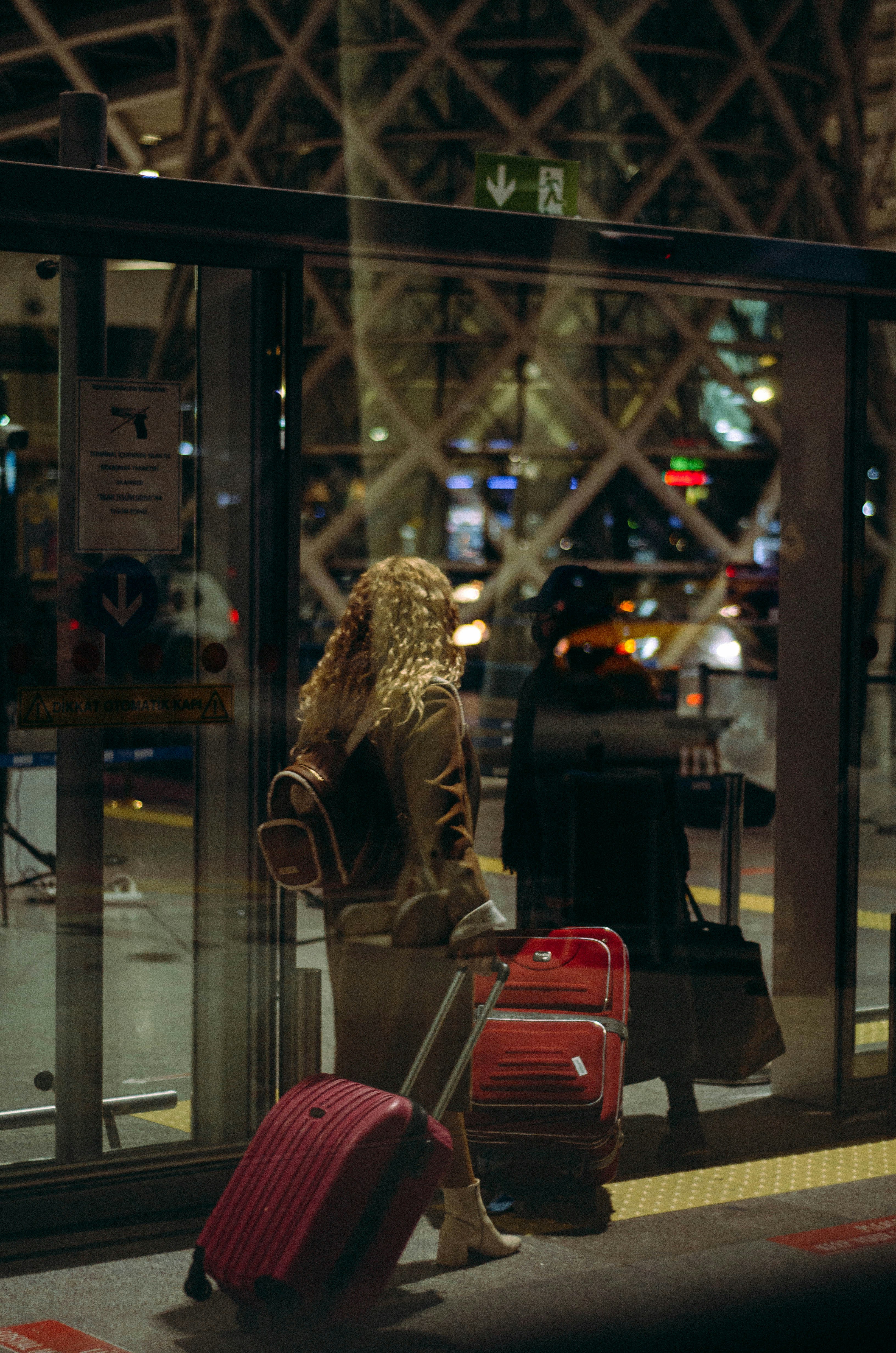 Traveler with Blush of Red: Night Gate at the Terminal