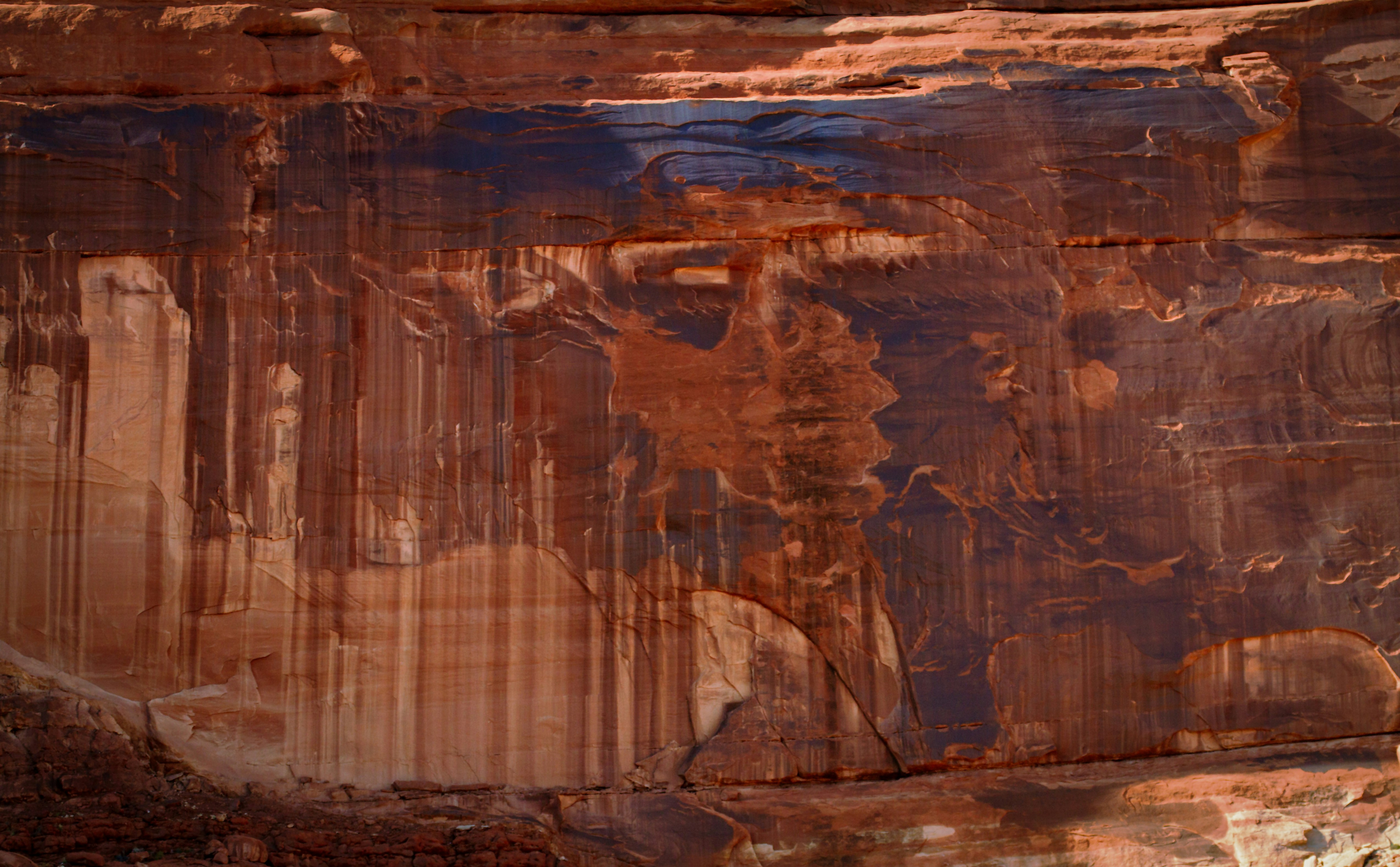 Intricate patterns and textures on a weathered rock face, showcasing the natural artistry of erosion and geological history.