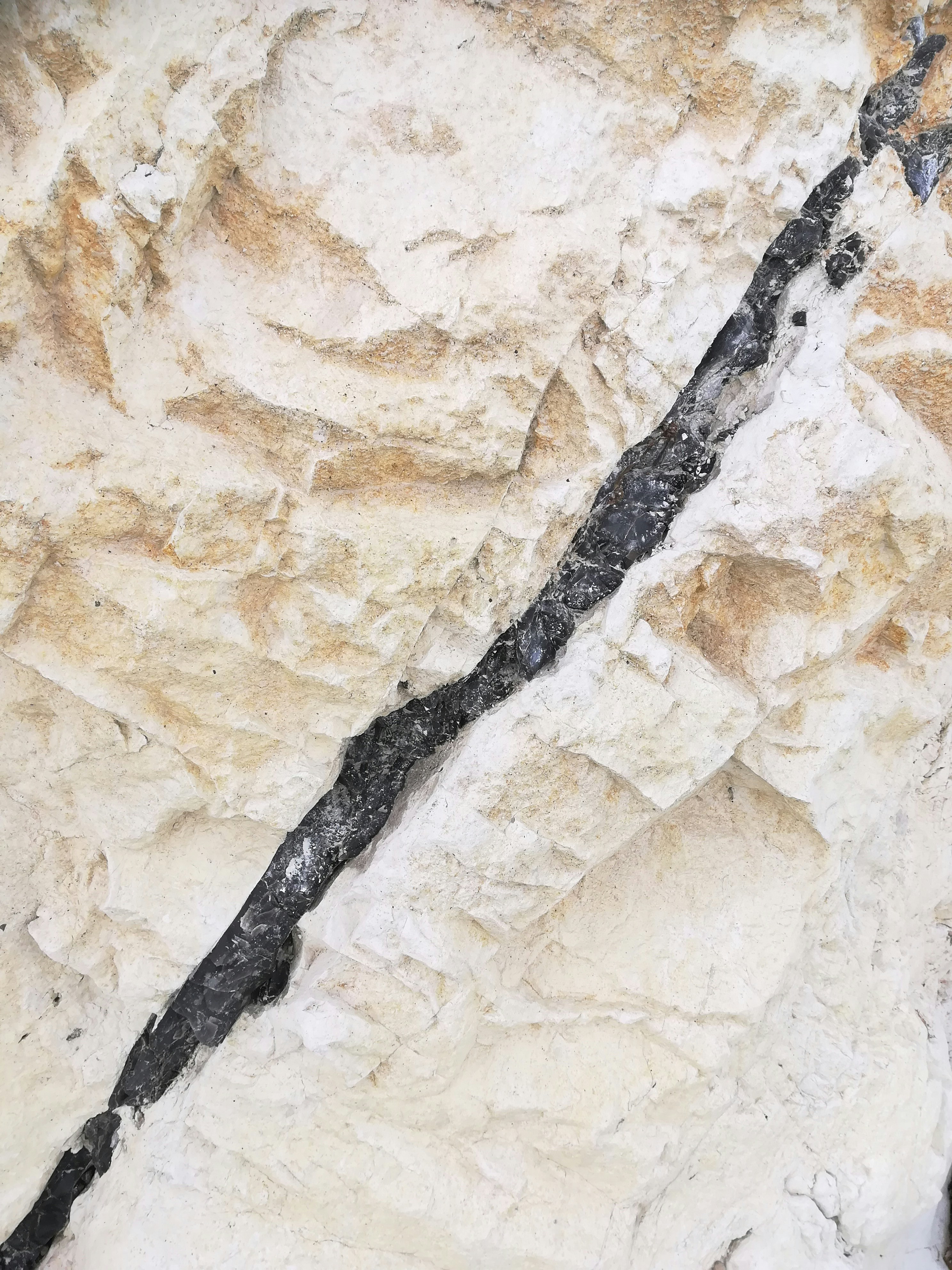 Crack in the Canyon: A Striking Vein in Pale Stone
