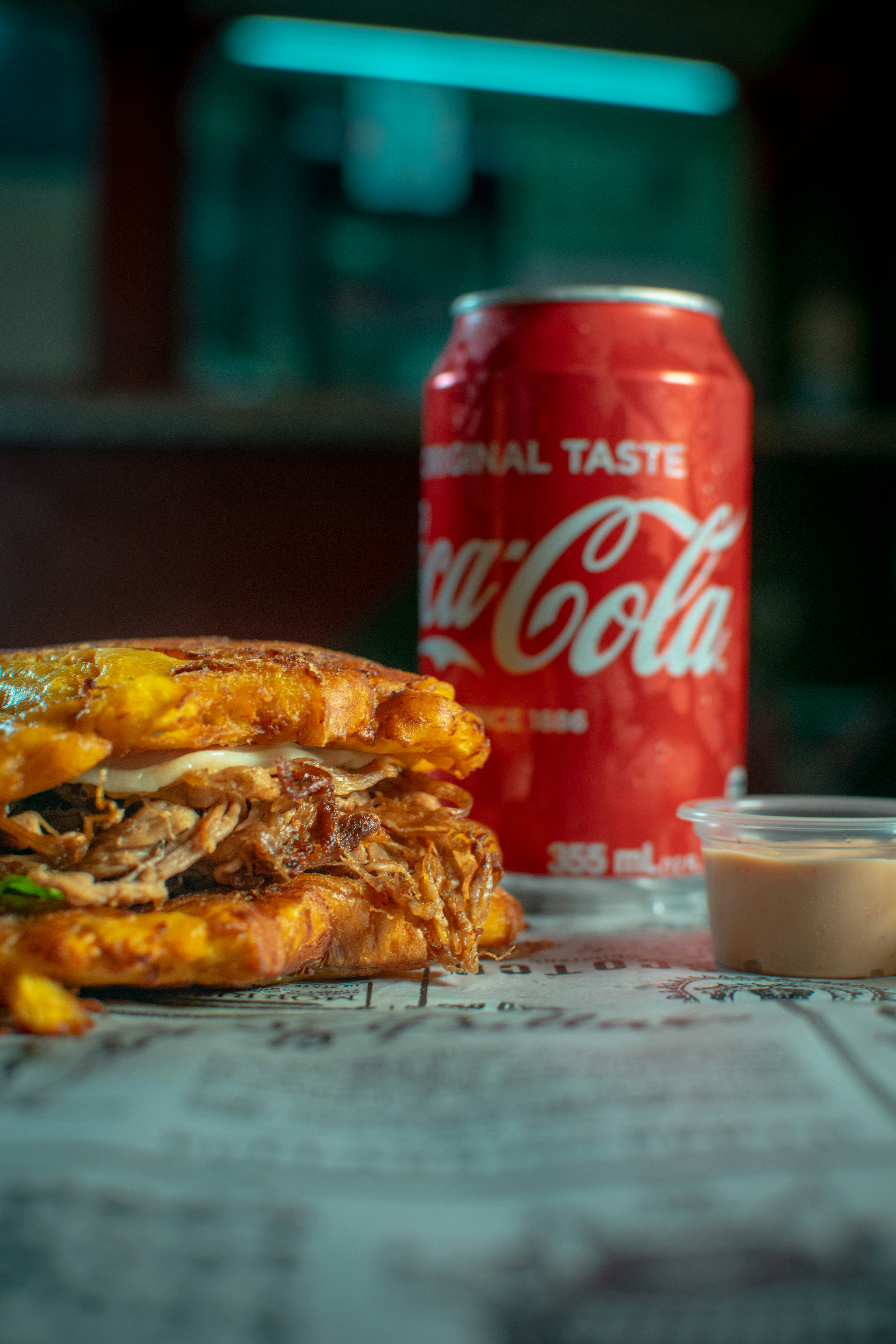 a close up of a sandwich near a can of soda