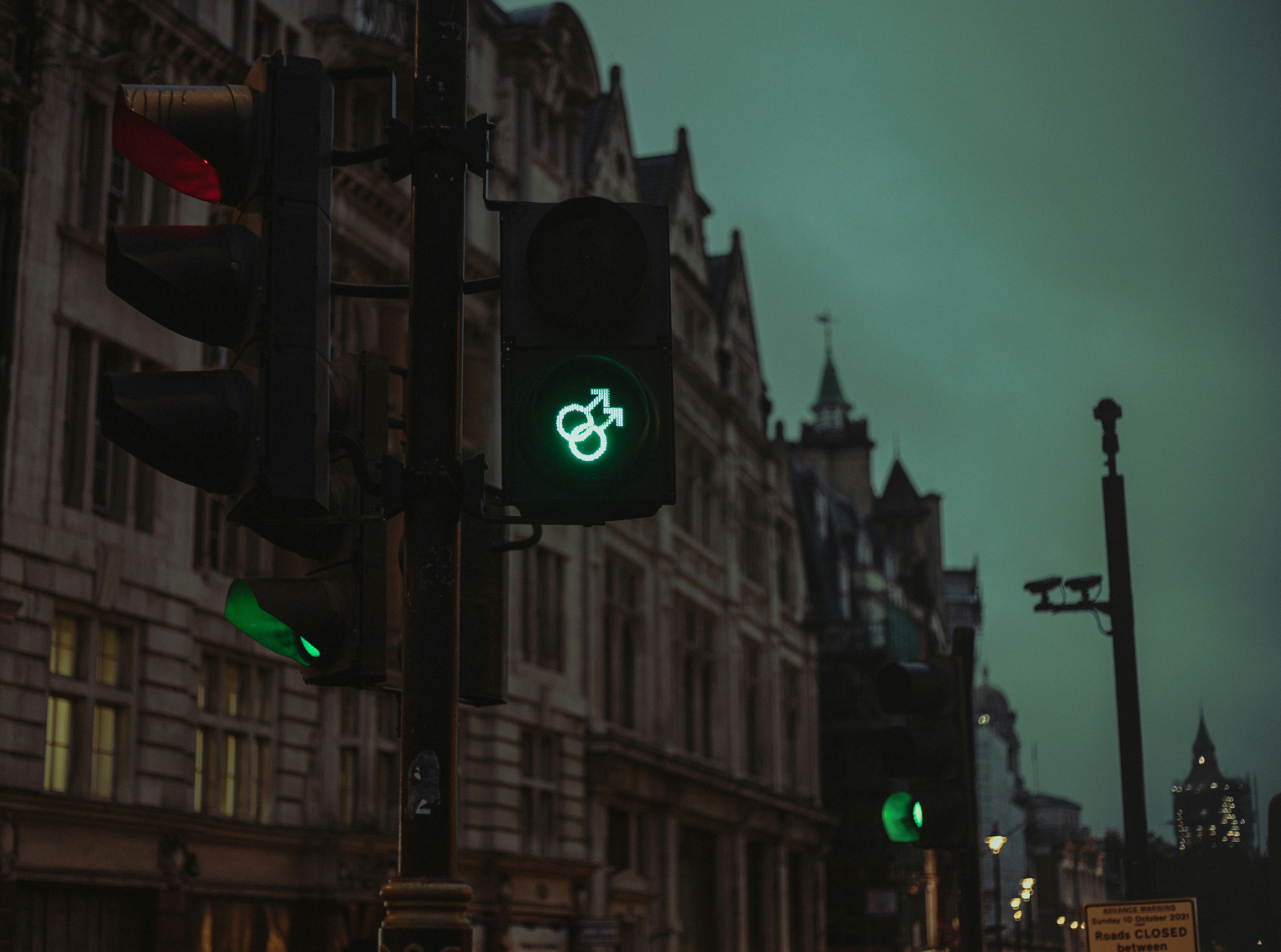 a green traffic light sitting on the side of a road