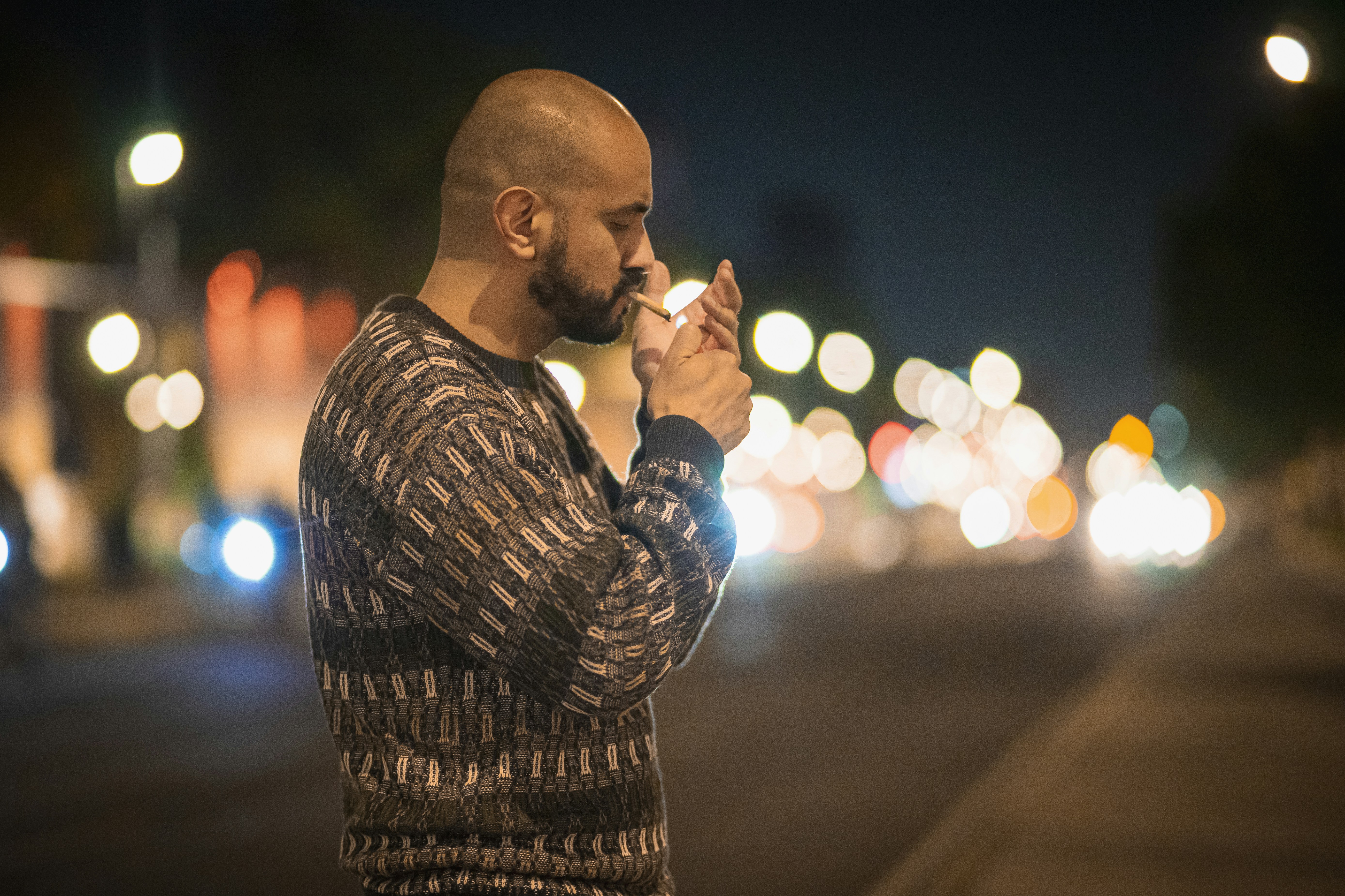 A man smoking a cigarette on a city street photo – Free Cdmx Image on ...
