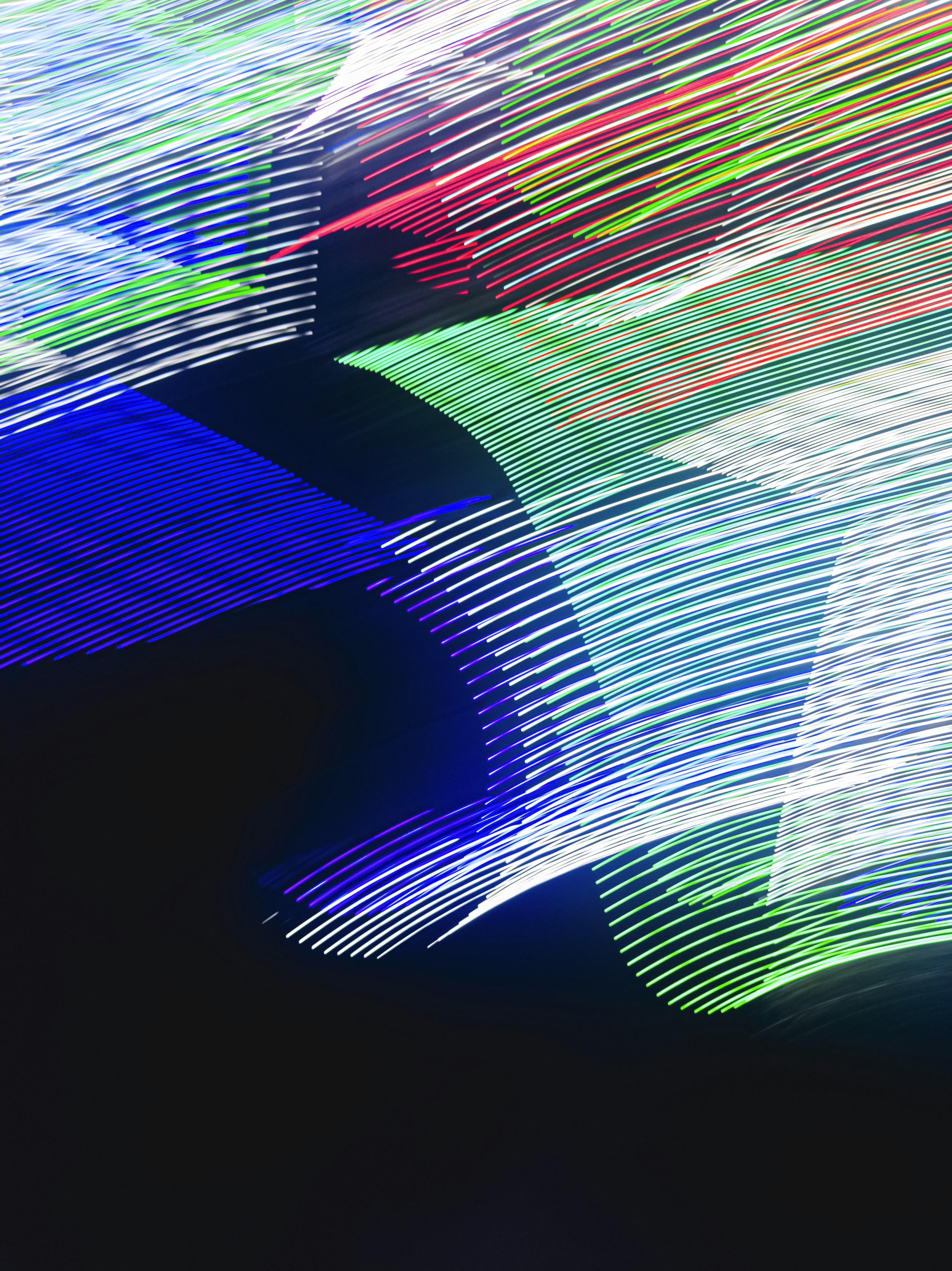Silhouette in a Cascade of Neon Light Streaks