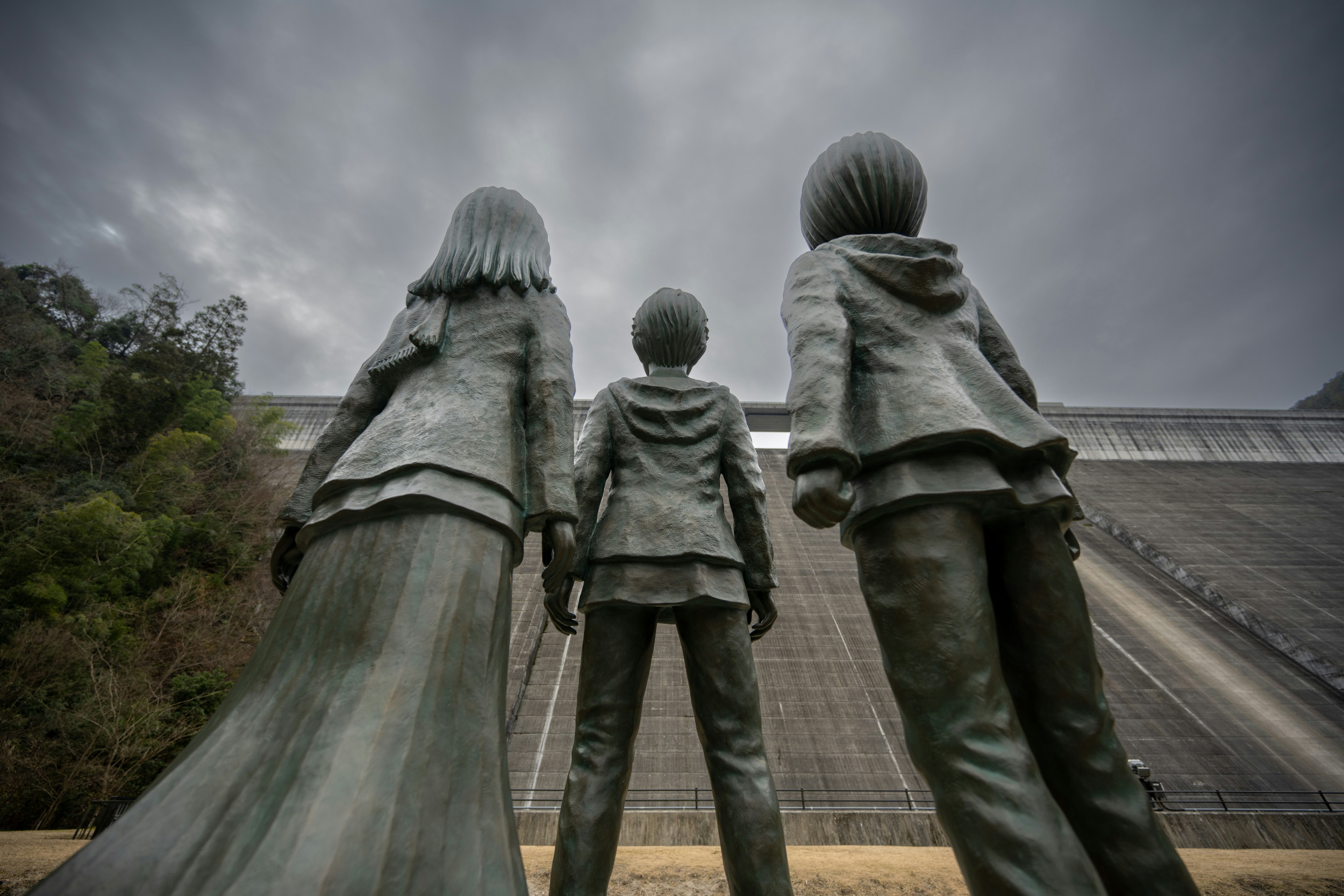 Sentinels of the Dam: Trio of Figures Gaze at a Monolithic Wall