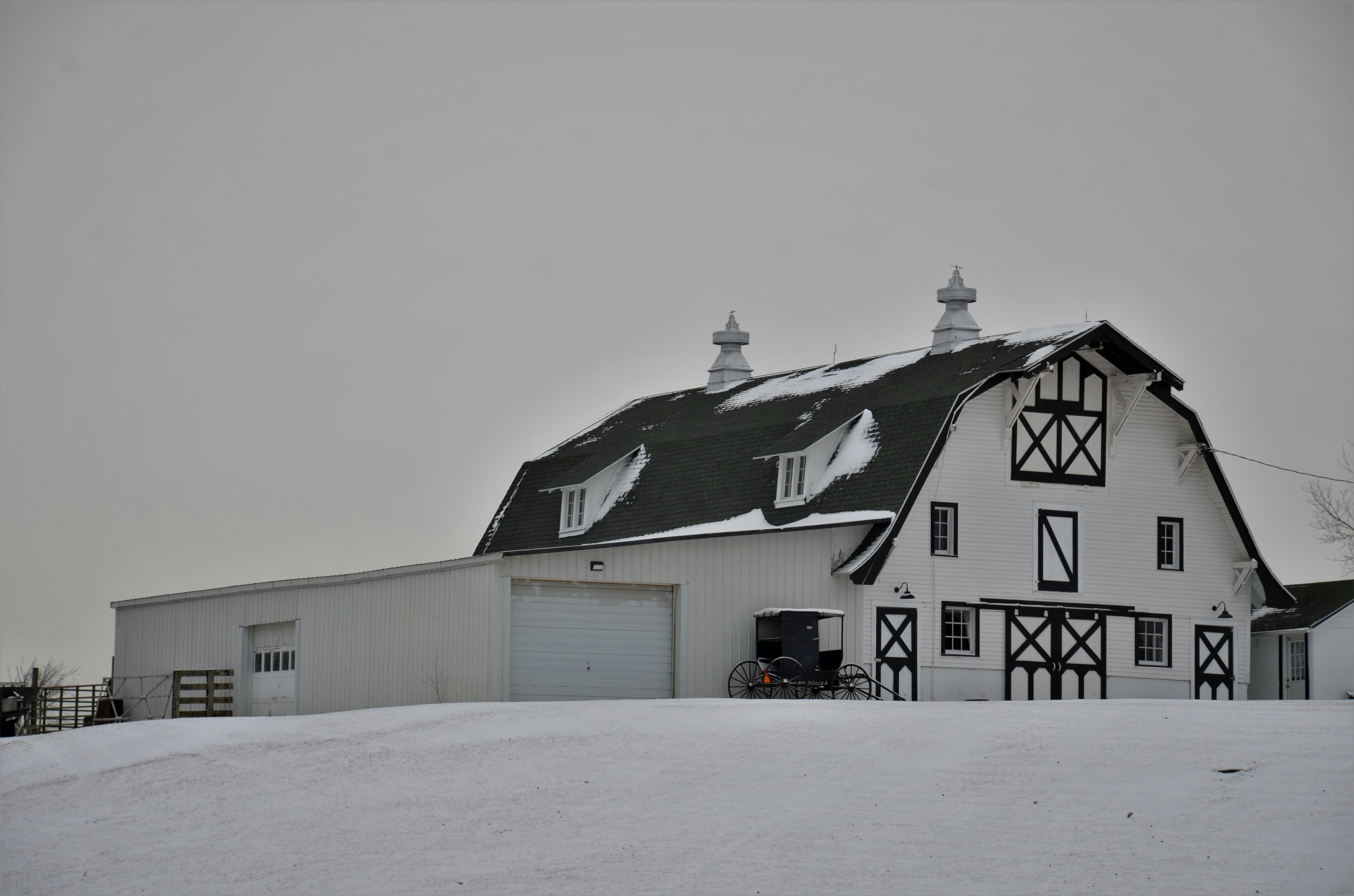 A large white barn with a black roof photo – Free Grey Image on Unsplash