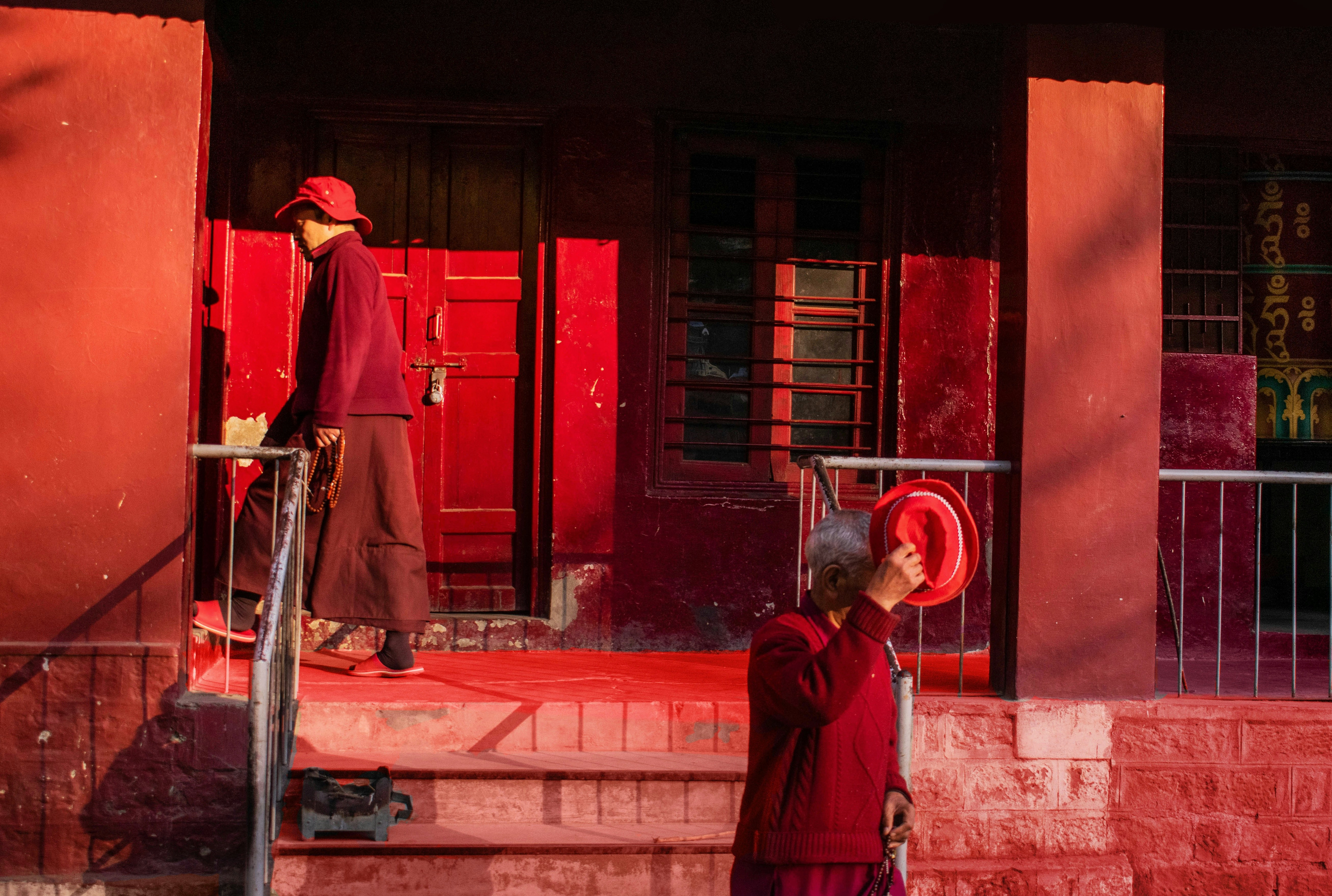 Crimson Ring Over Quiet Steps: A Red-Washed Street Portrait