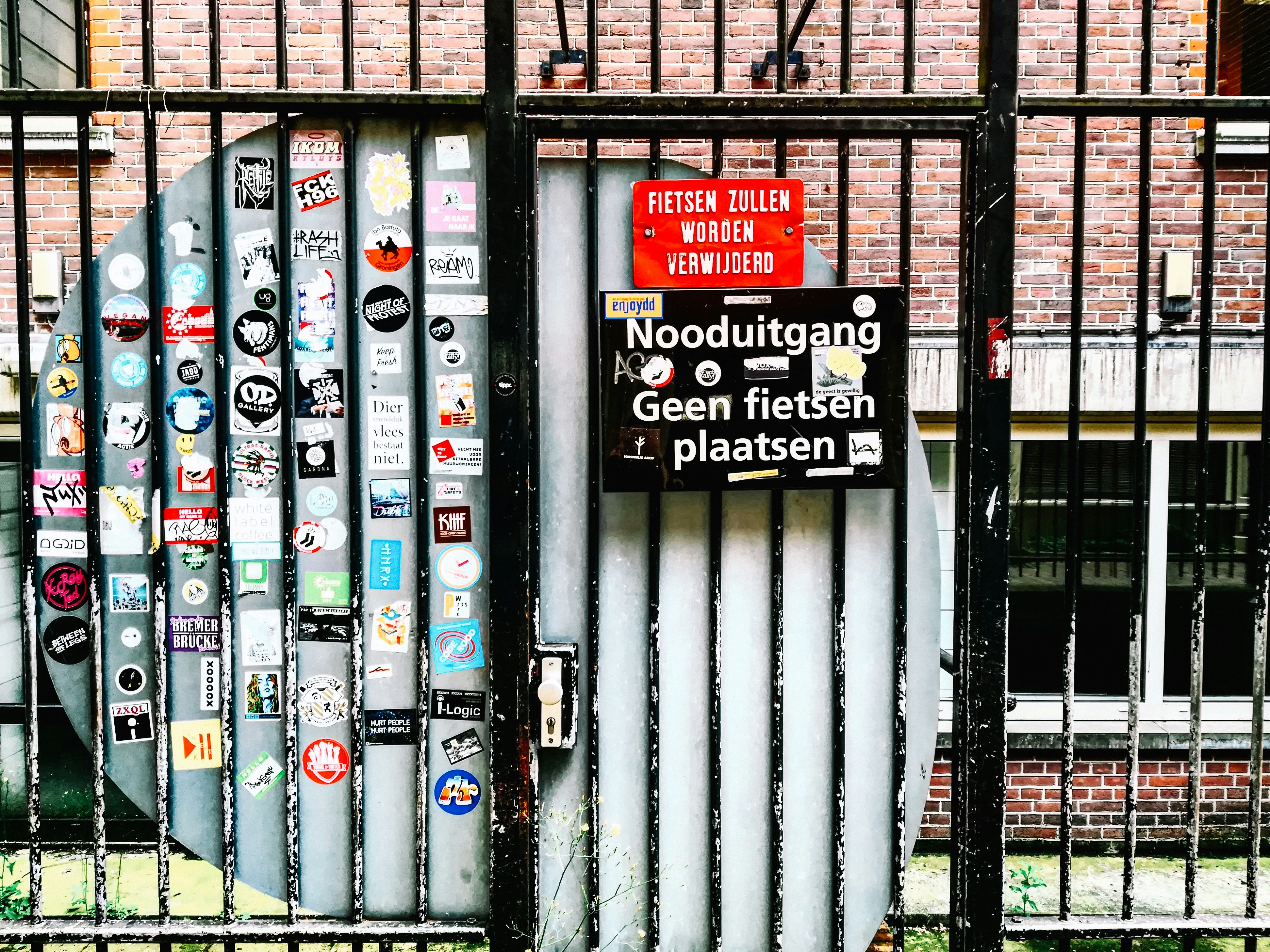 A gate with a bunch of stickers on it photo – Free Amsterdam Image on ...